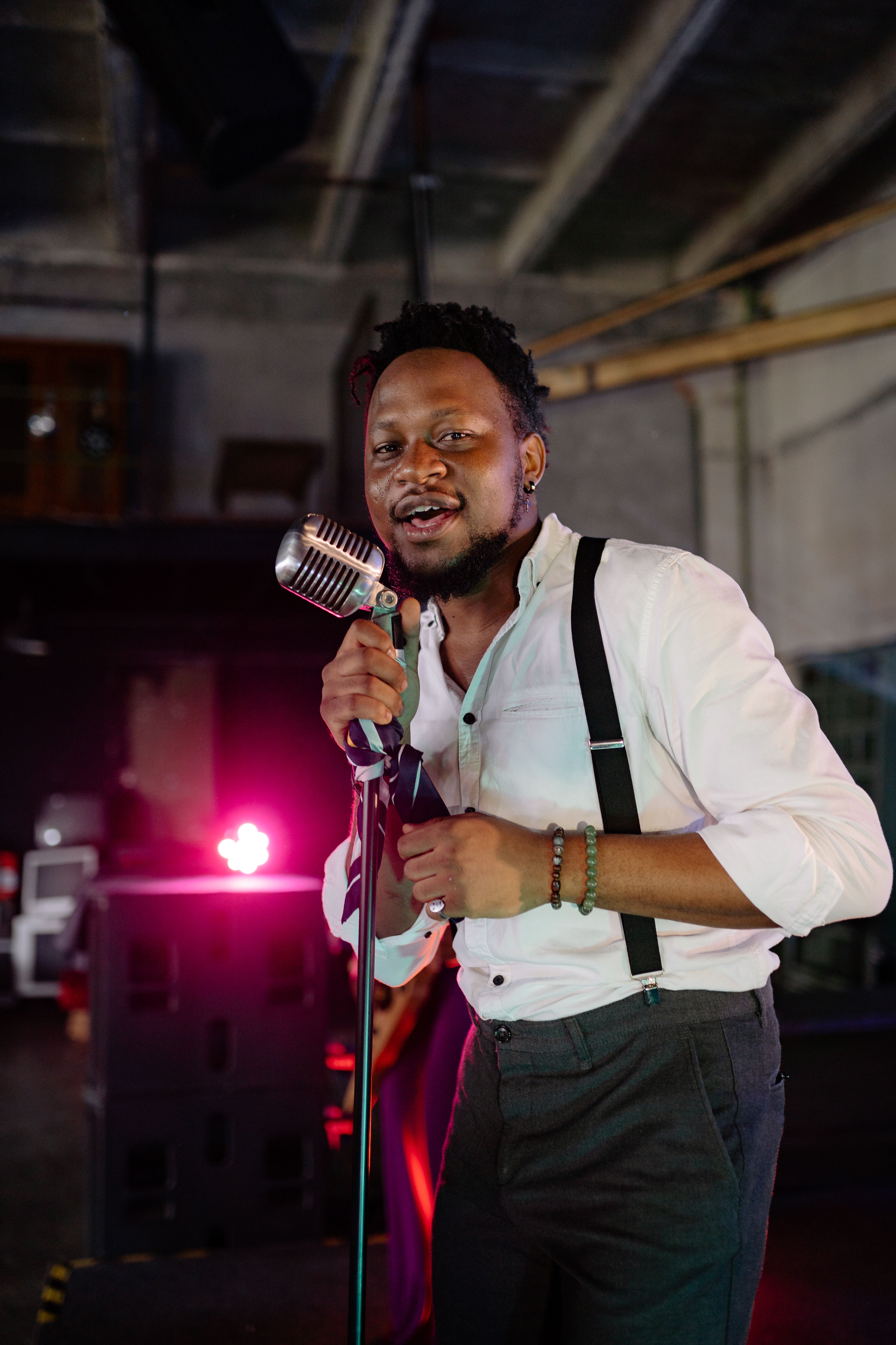 A Man Holding a Microphone and Singing · Free Stock Photo