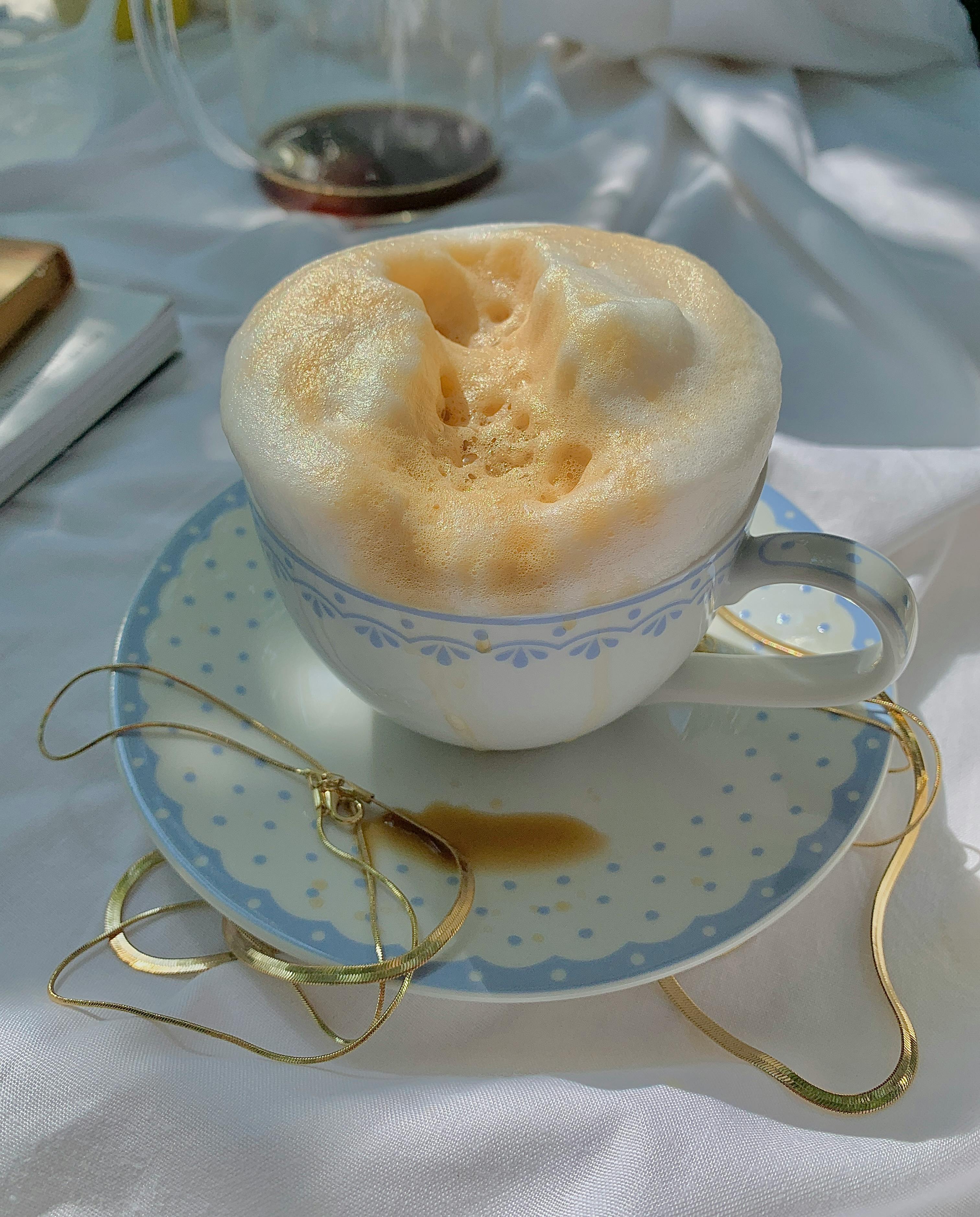 Coffee Foam in White Ceramic Cup With Saucer on Table · Free Stock Photo