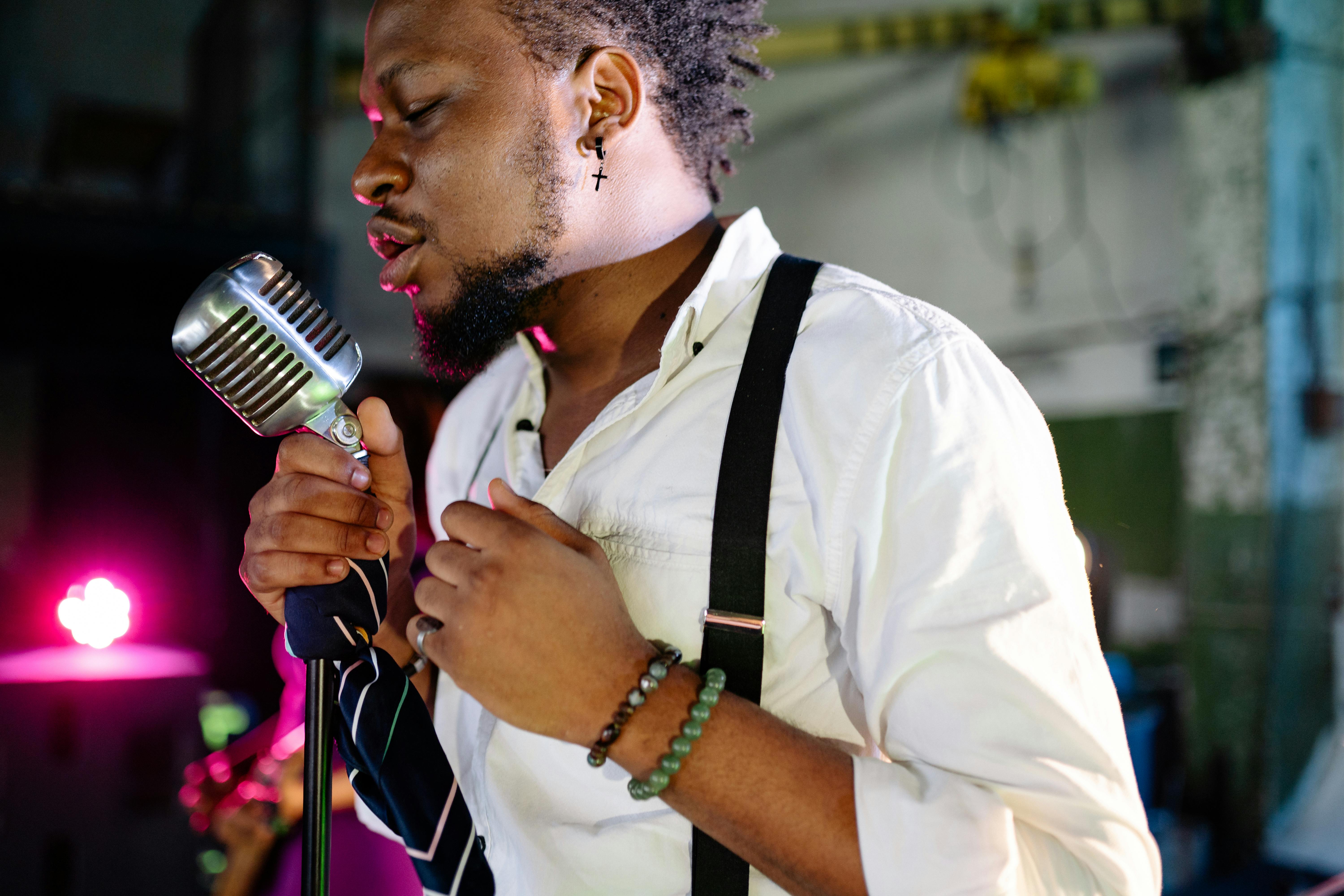 A Female Singer Singing Emotionally · Free Stock Photo