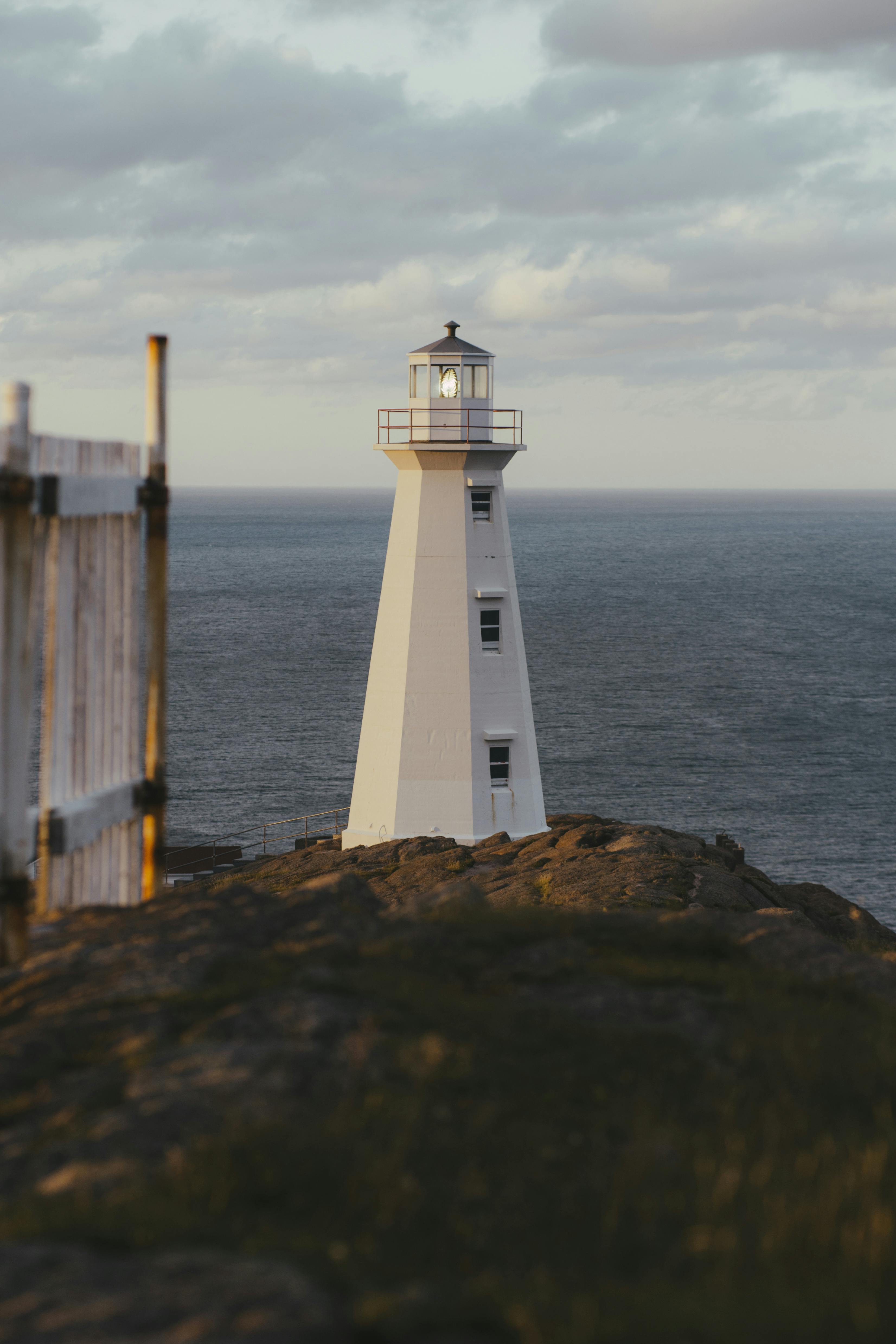 People Standing in Front of White Concrete Lighthouse during Daytime ...