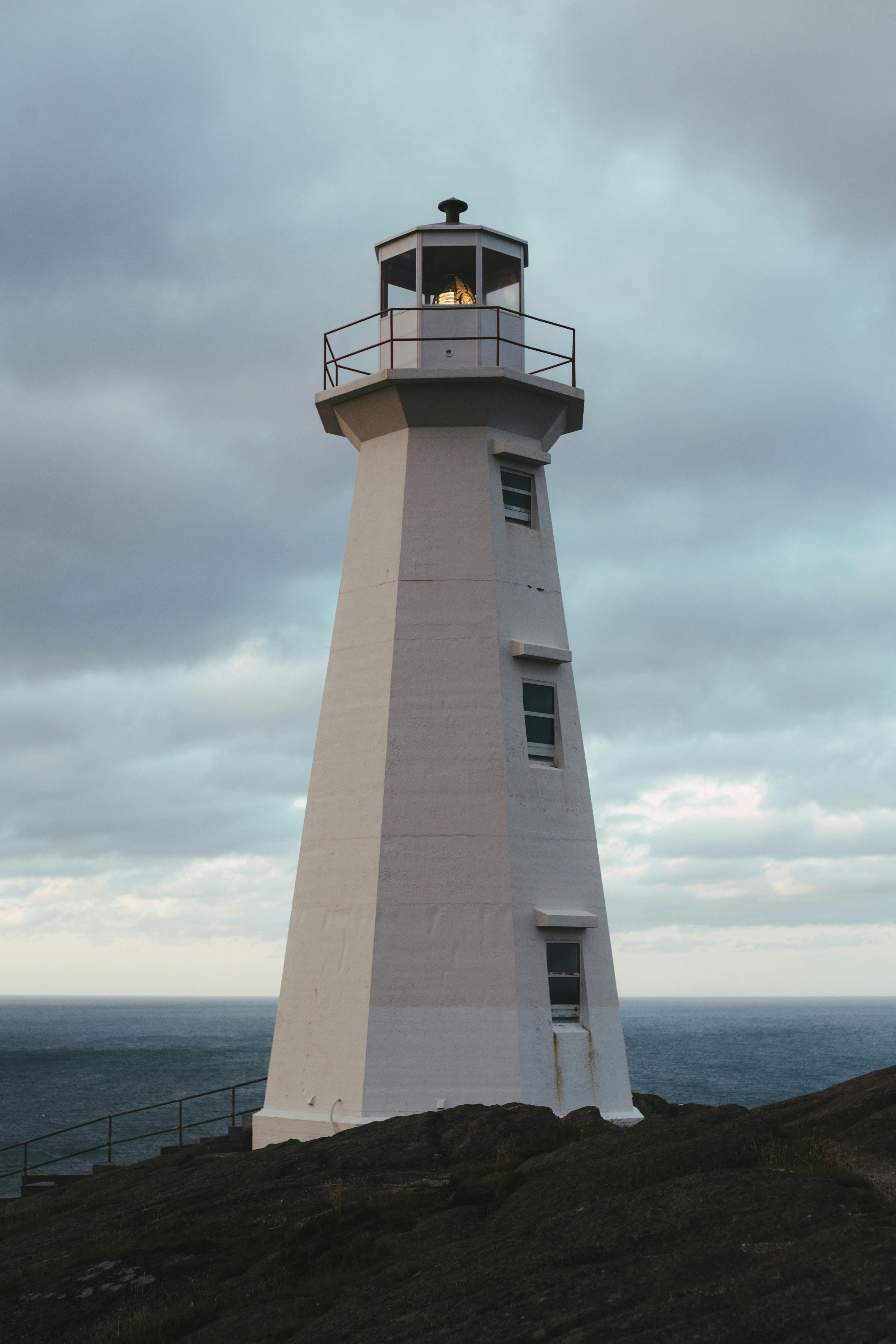 Photo of a White Lighthouse Near an Ocean · Free Stock Photo