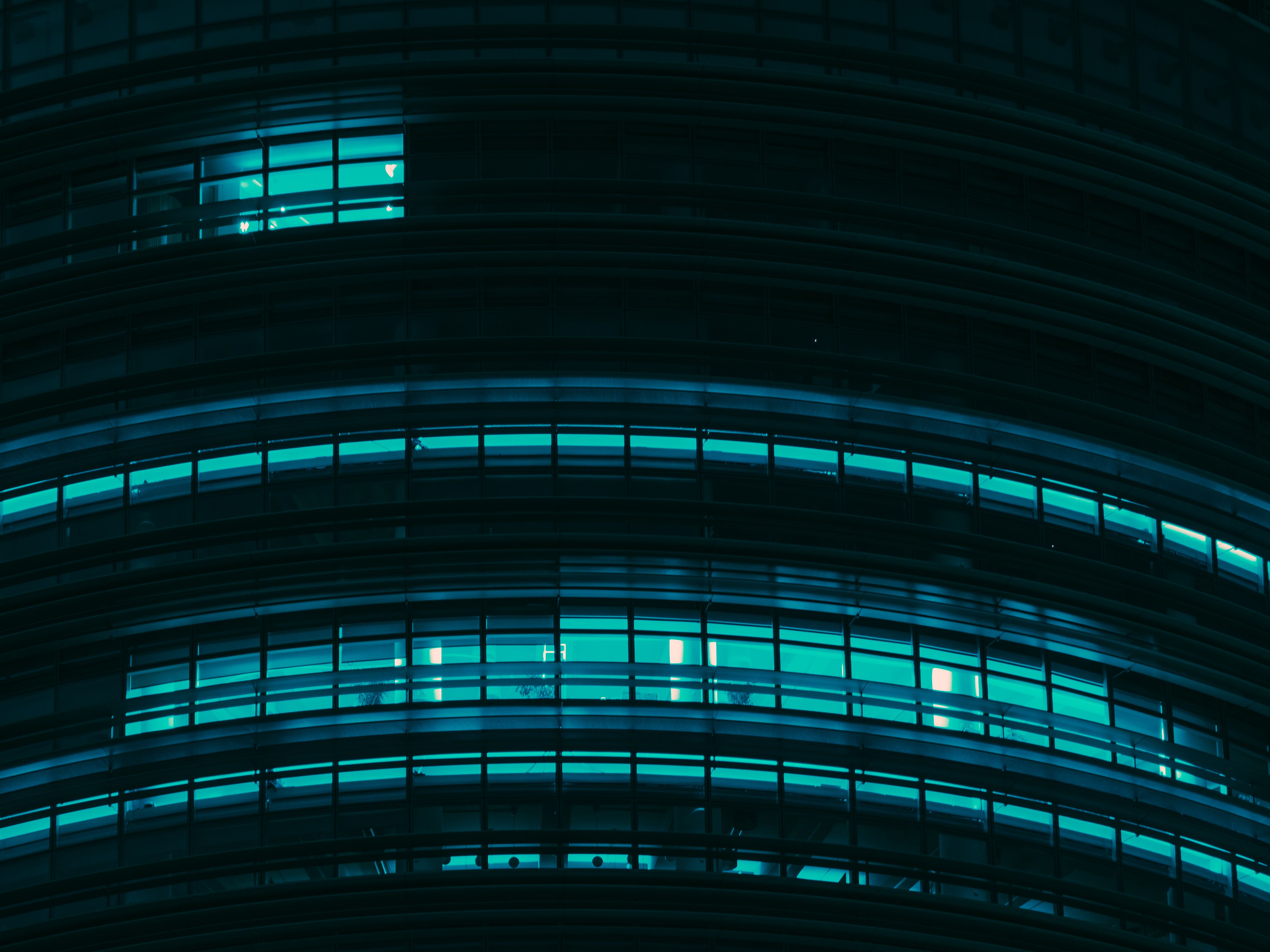 A Building with Glass Windows at Night · Free Stock Photo