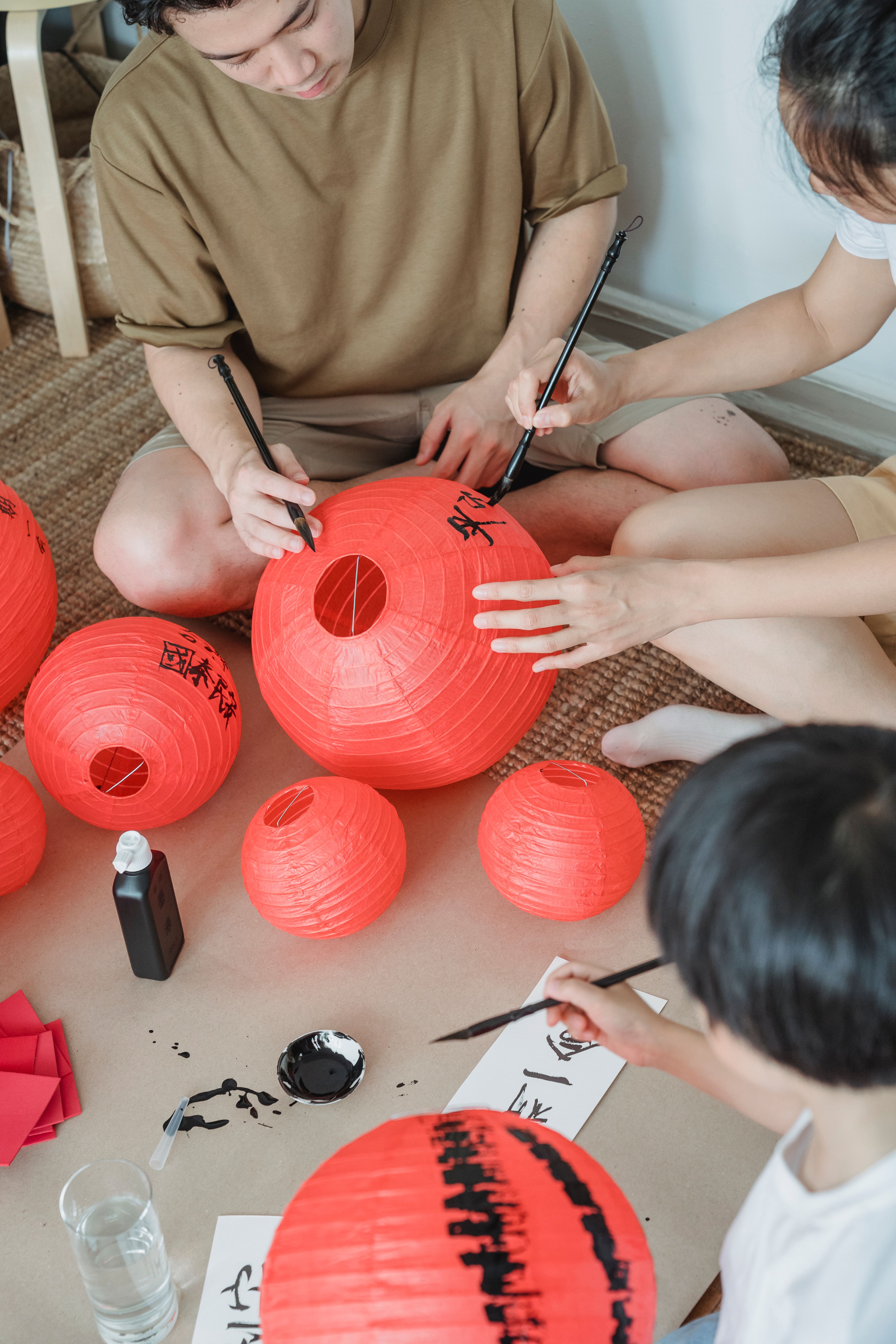 People Writing on Paper Lanterns · Free Stock Photo