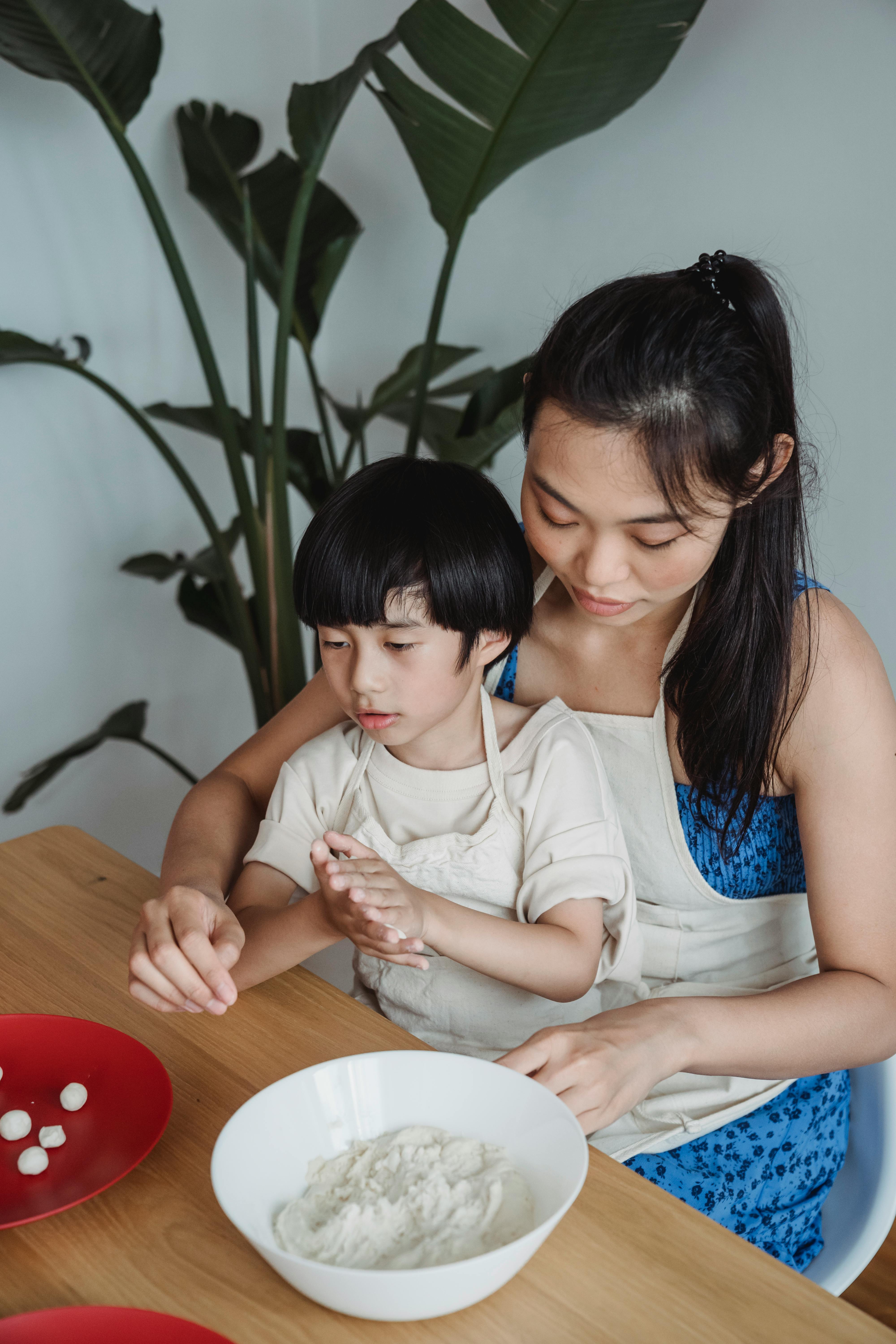 Child Sitting on Woman's Lap · Free Stock Photo