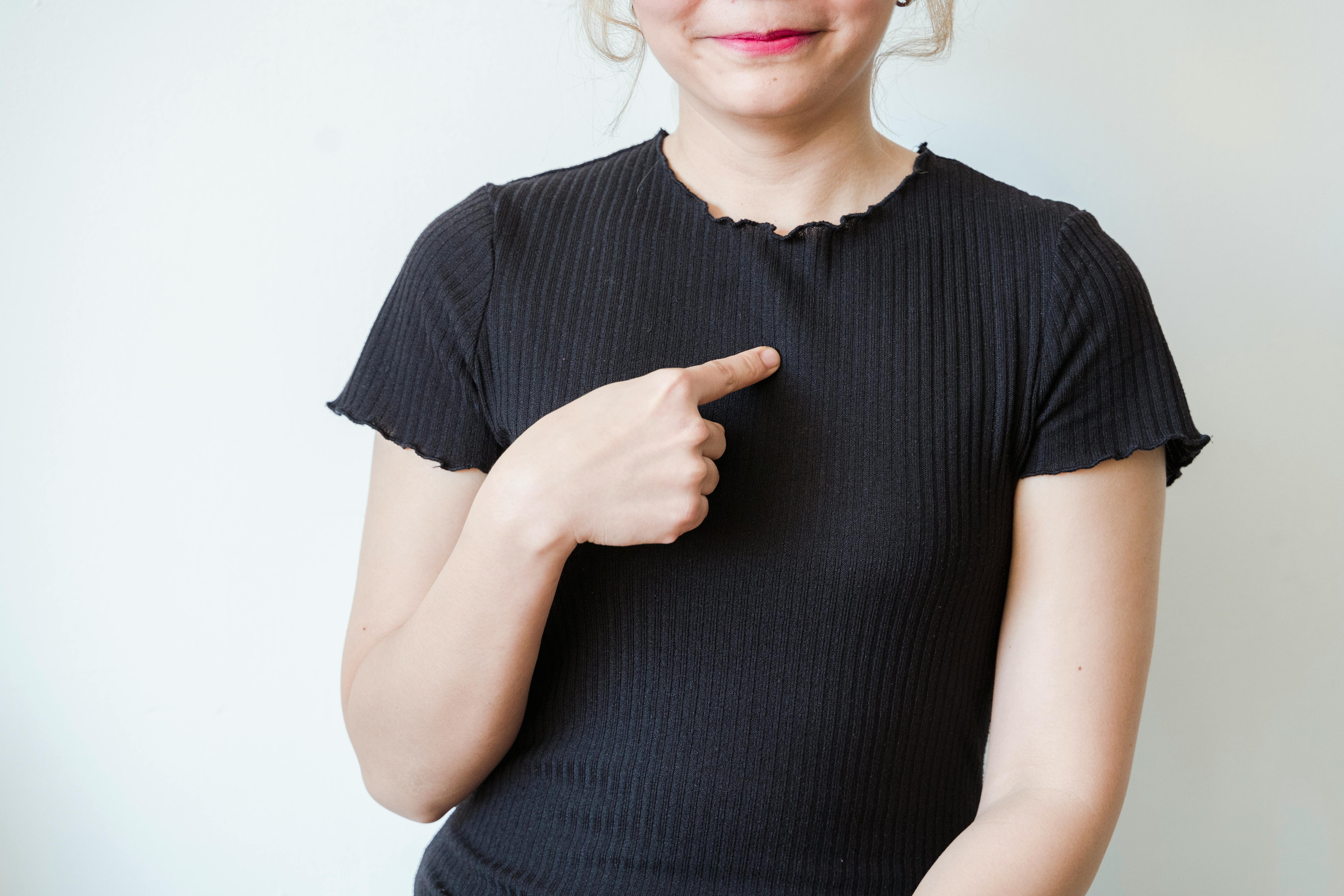 Girl in Black Shirt Pointing Finger to Herself · Free Stock Photo