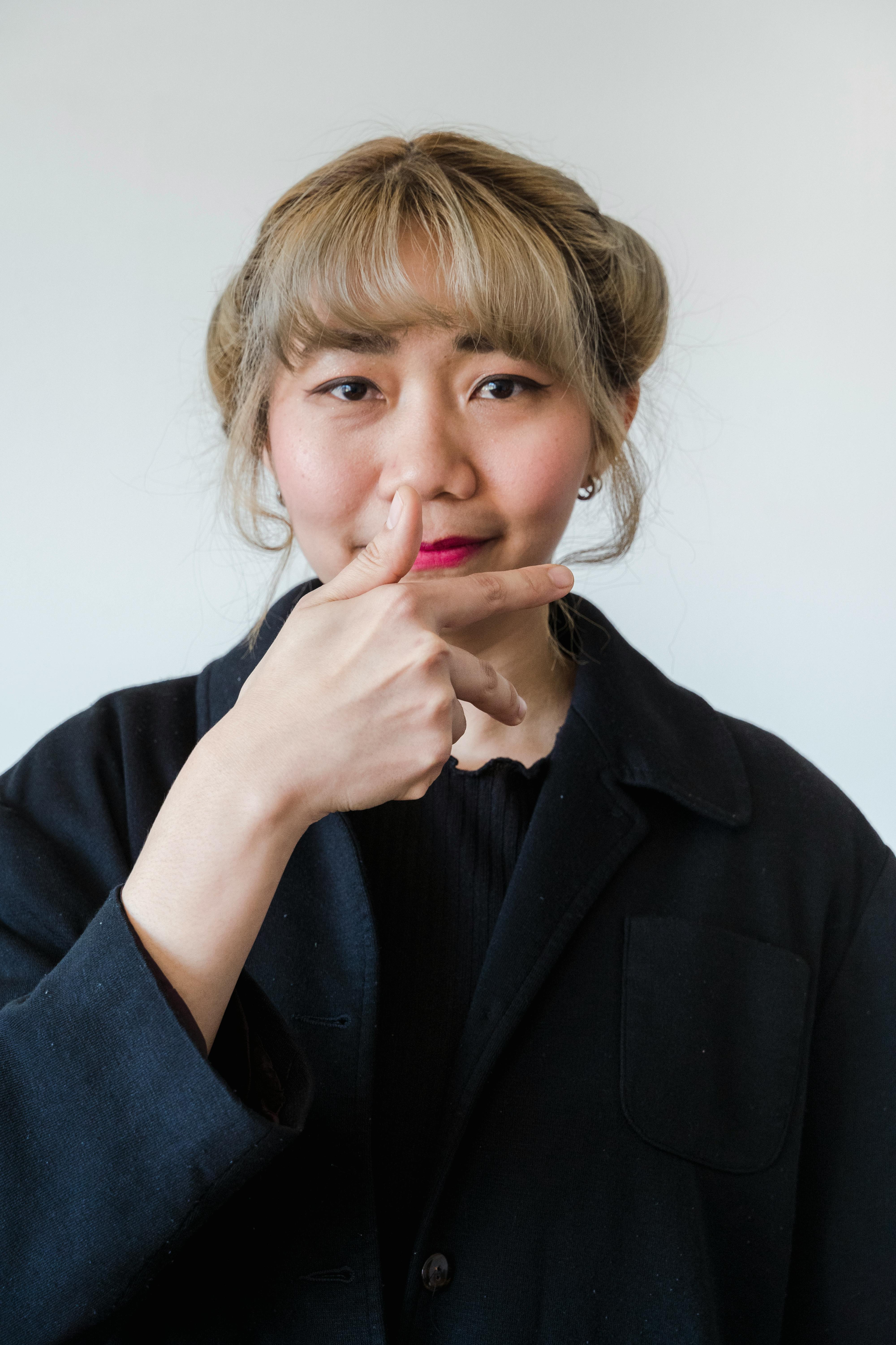 A Person in Black Coat doing Sign Language · Free Stock Photo
