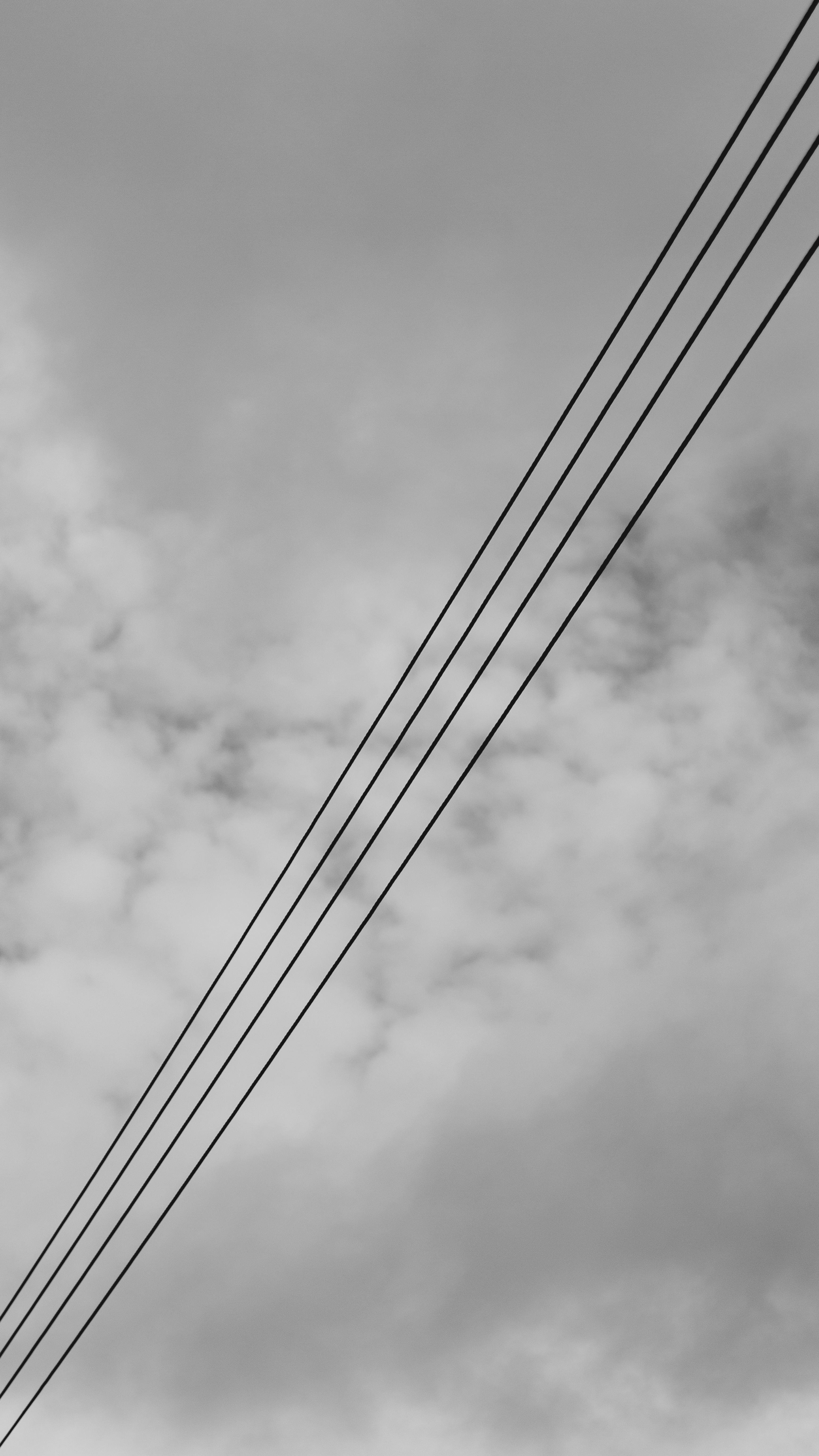 Power Lines Under a Cloudy Sky · Free Stock Photo
