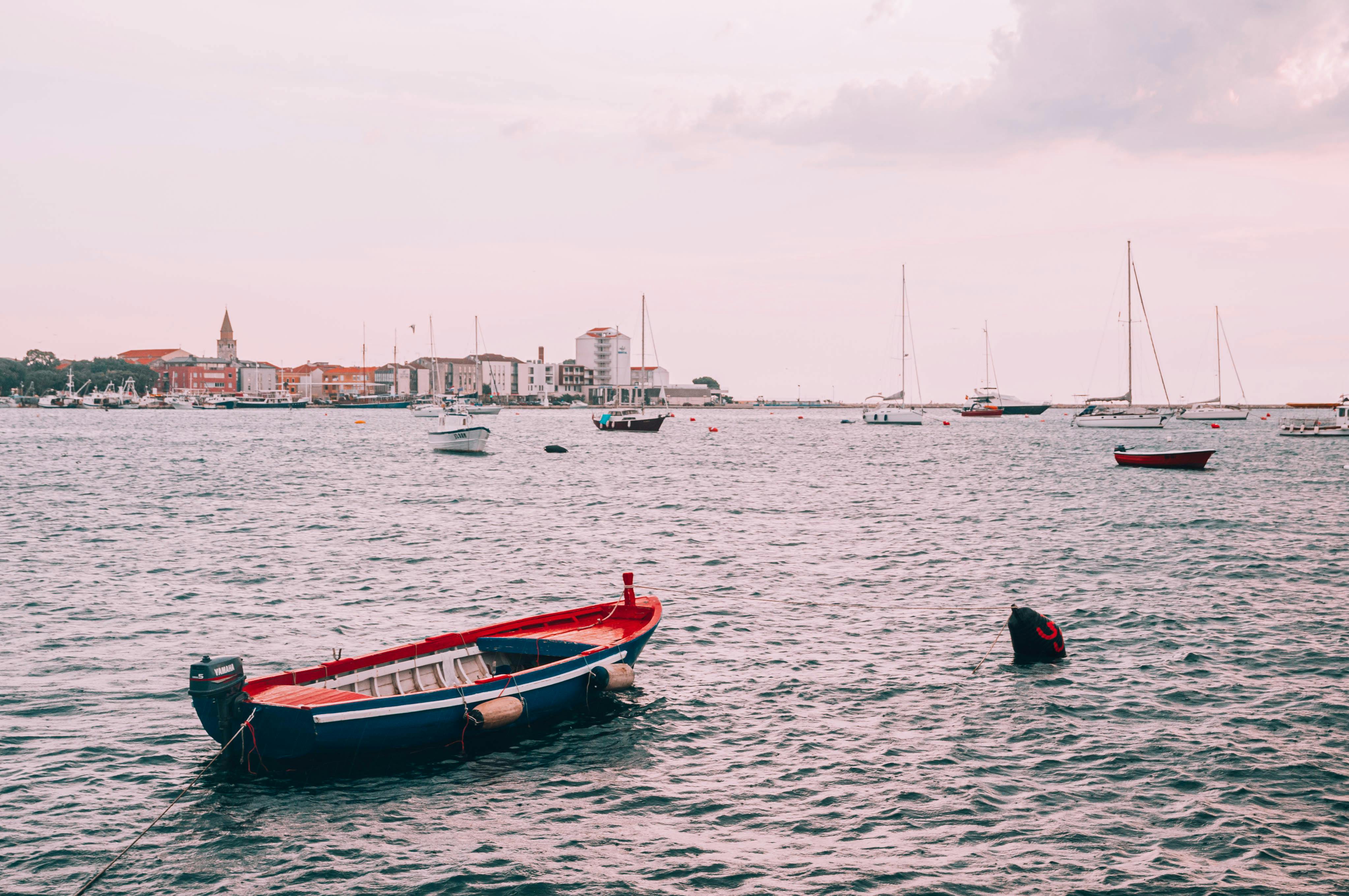 Red and Blue Boat on Body of Water · Free Stock Photo