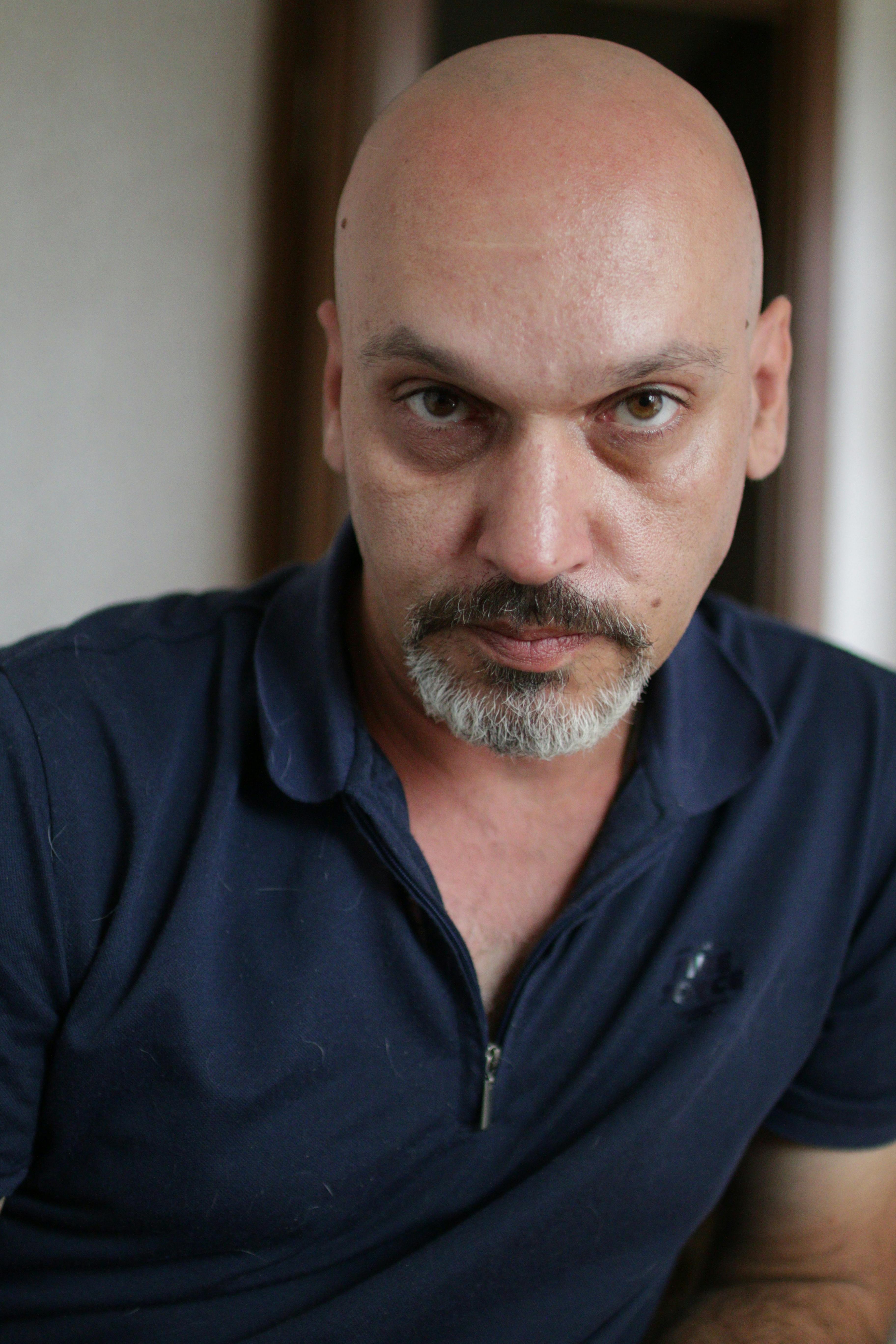 Bald Man with a Serious Facial Expression · Free Stock Photo