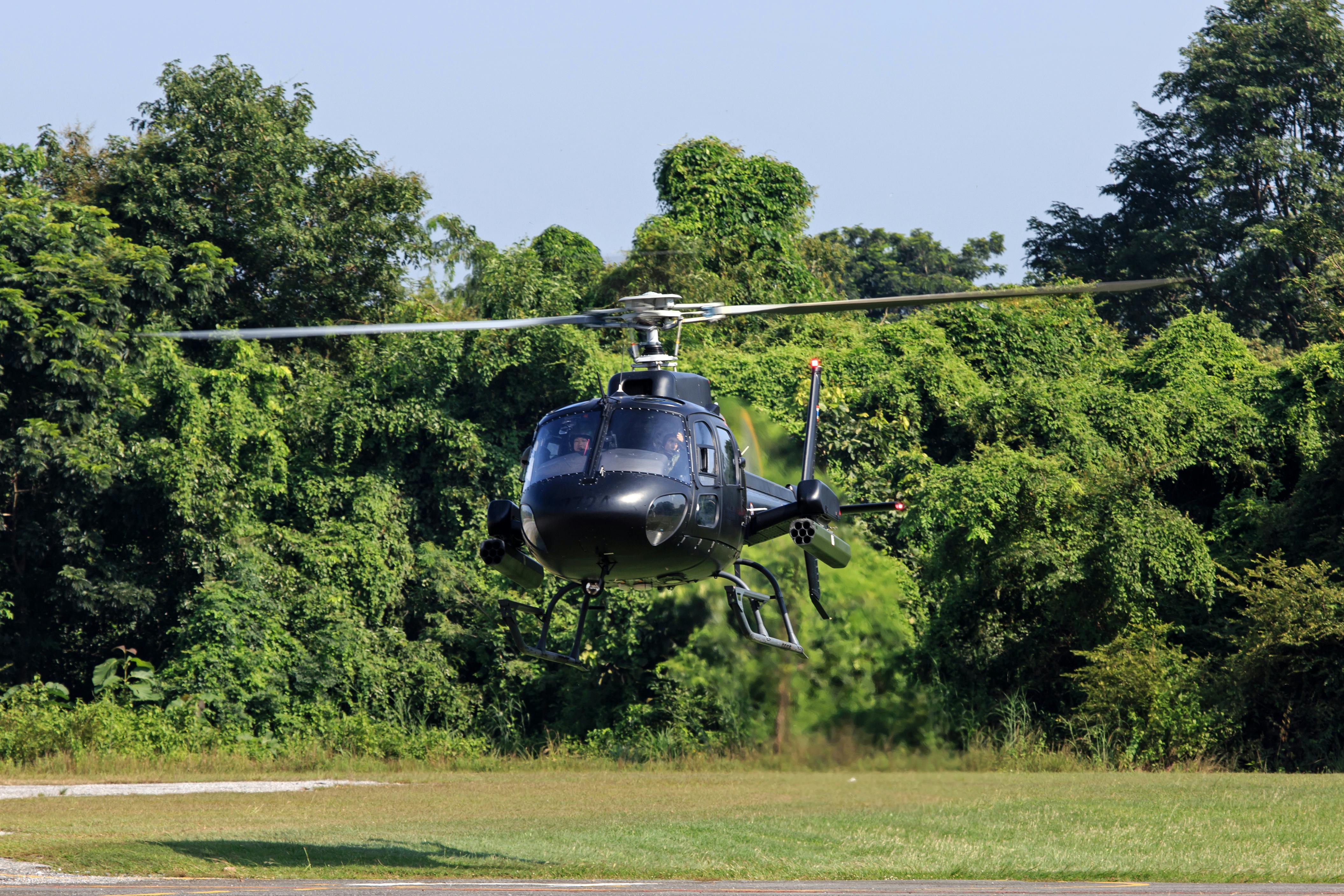 Black Helicopter over the Green Grassy Field · Free Stock Photo