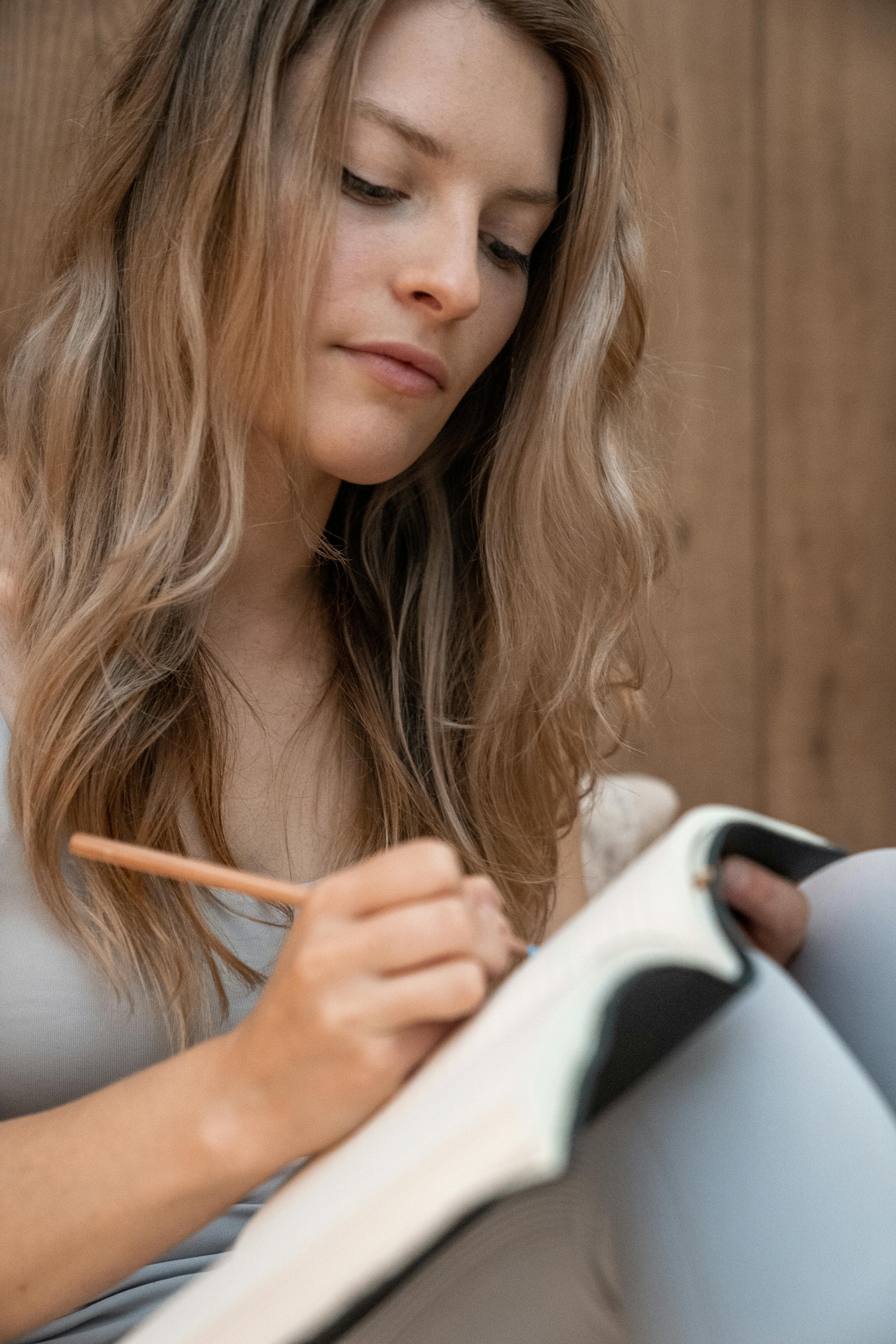 Beautiful Woman Writing on a Notebook · Free Stock Photo