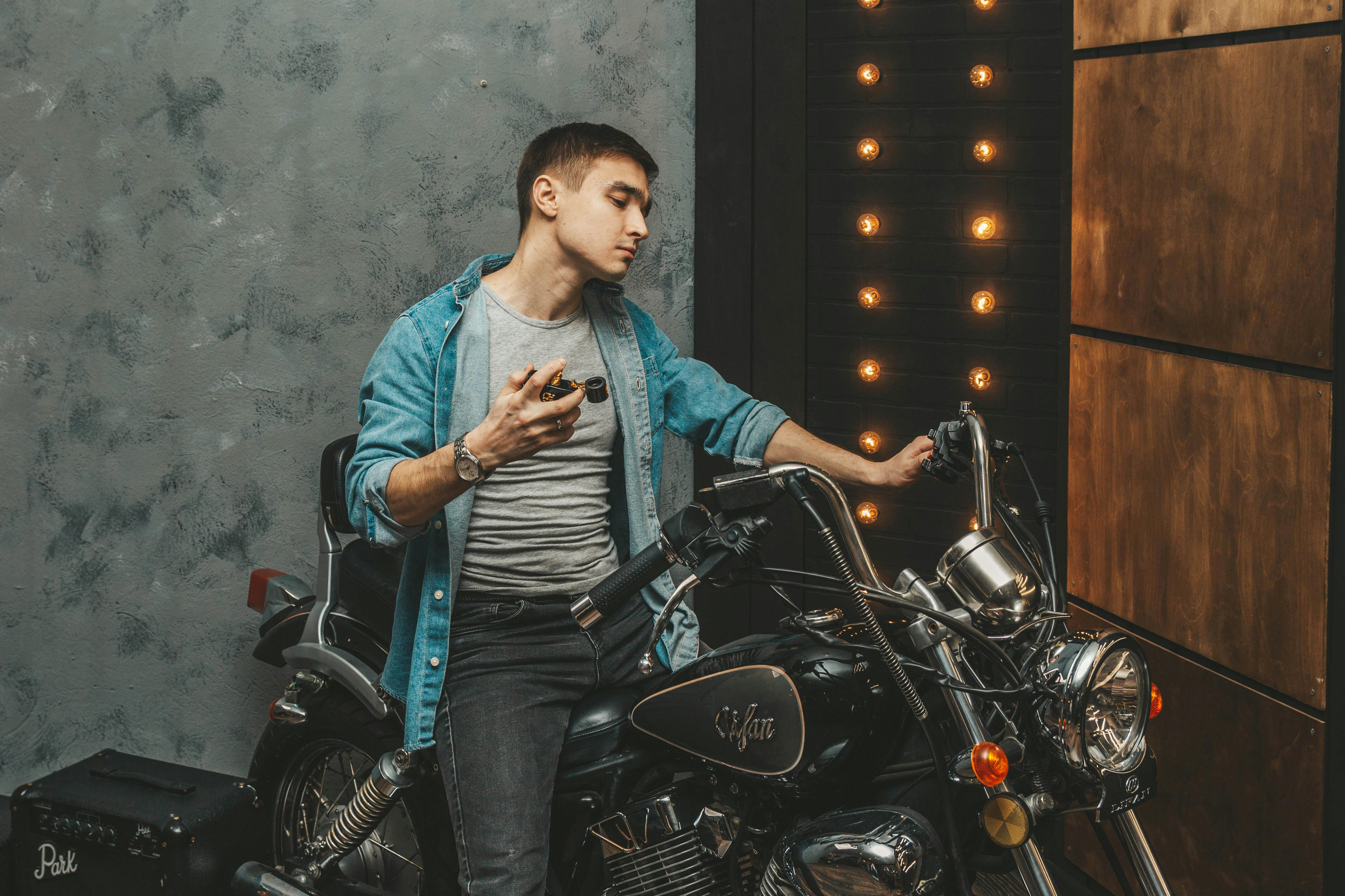 A Man in Blue Denim Jacket Riding a Motorcycle · Free Stock Photo