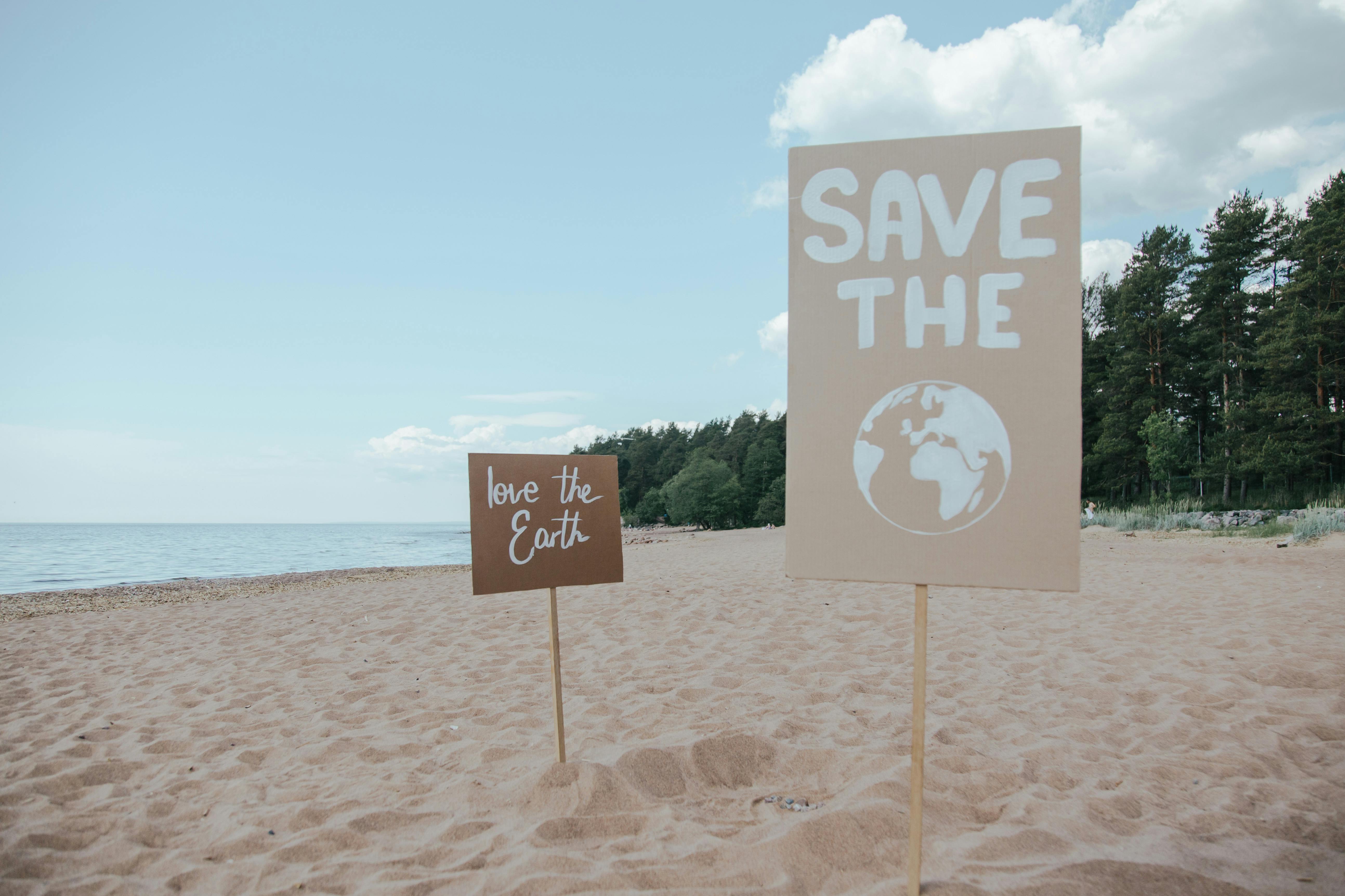 Signages With The Words Save The Earth and Love The Earth Planted on ...