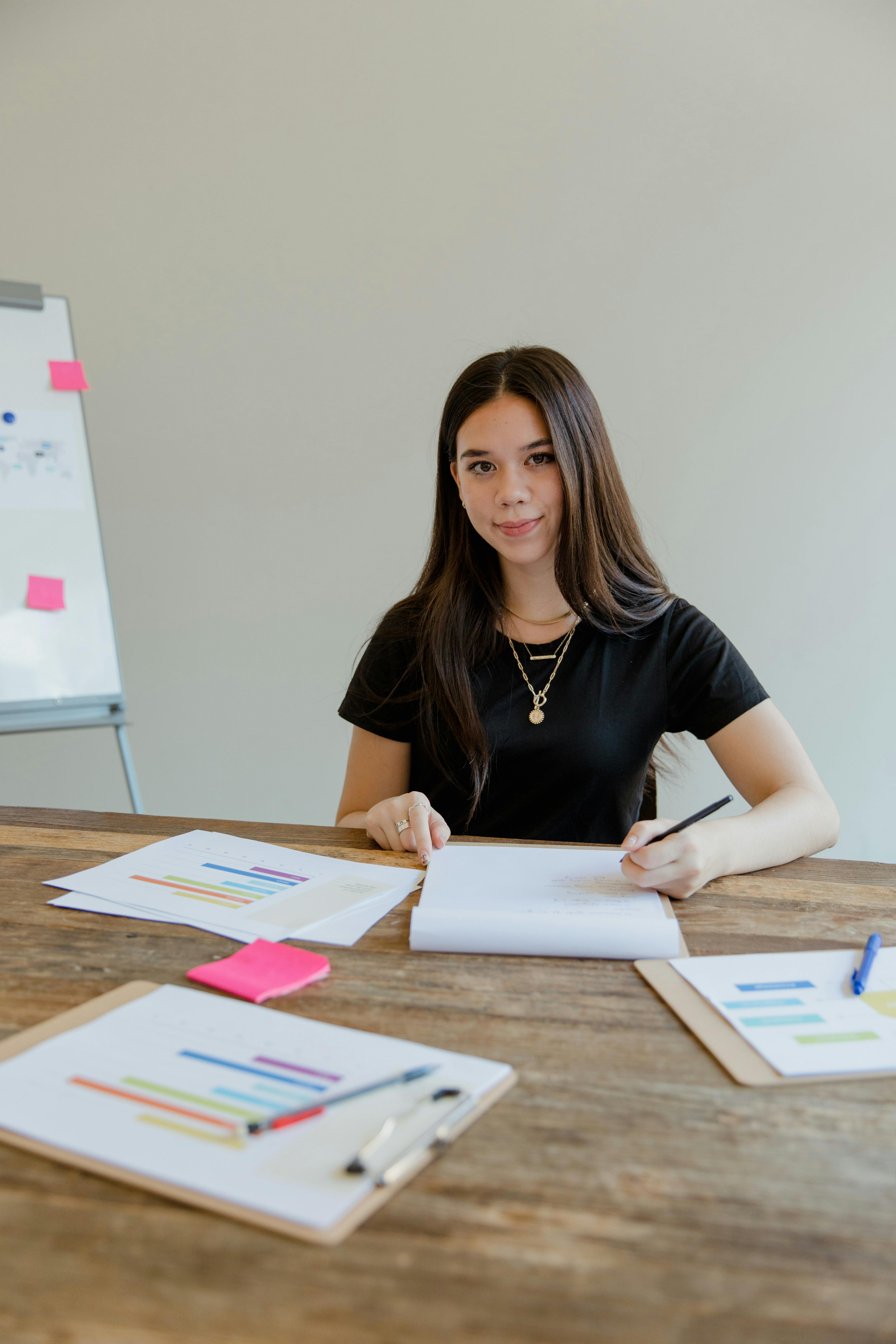 A Woman Writing in her Diary while Sitting on a Couch · Free Stock Photo