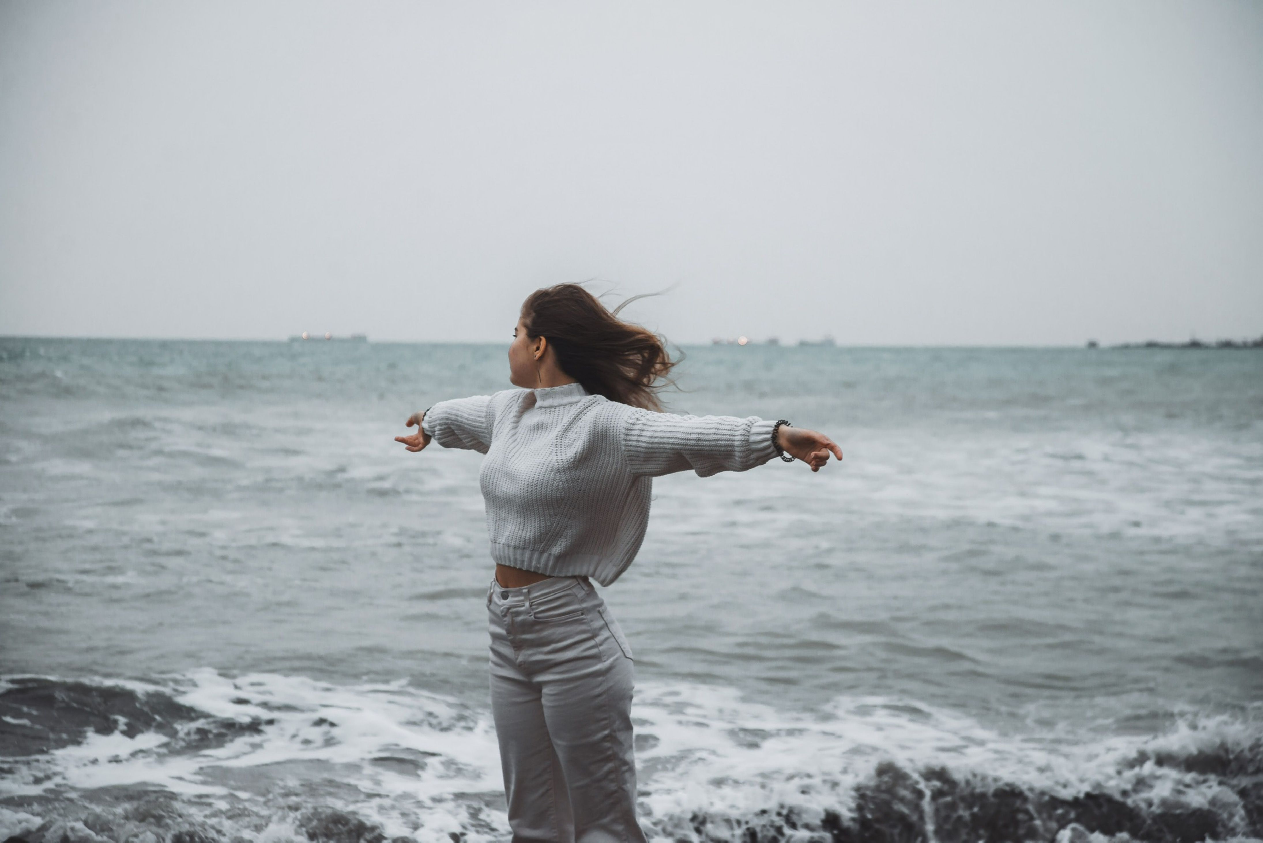 Woman Standing on Cliff · Free Stock Photo