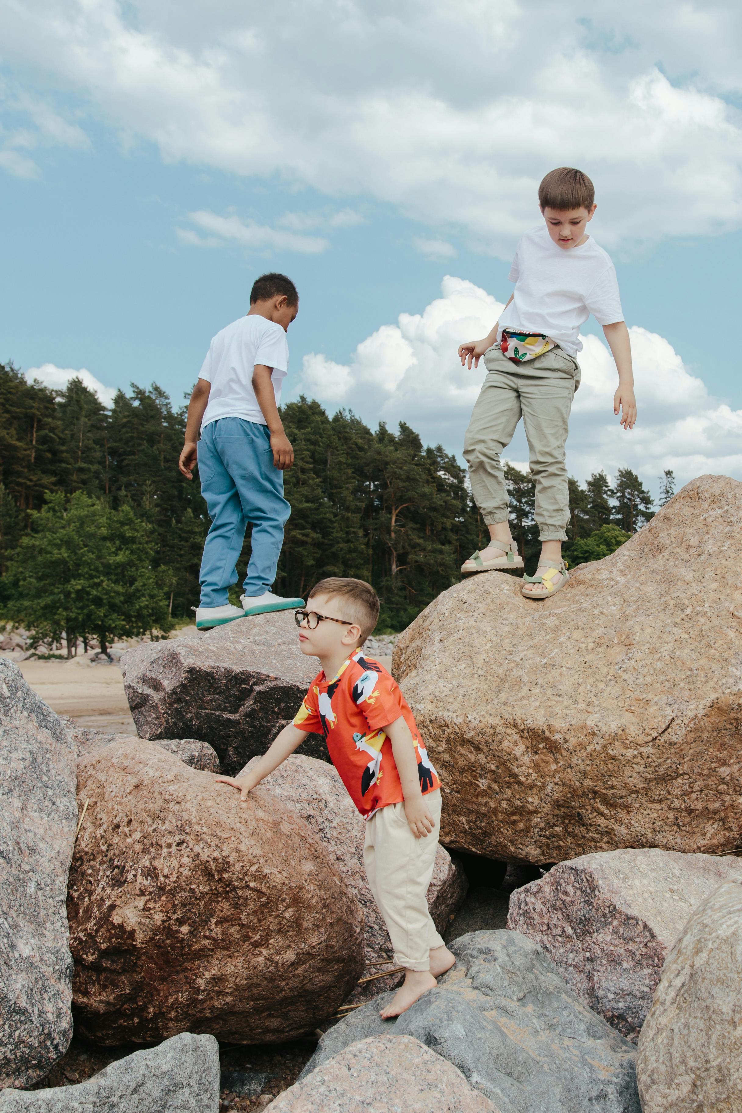 Kids Standing on Rocks · Free Stock Photo