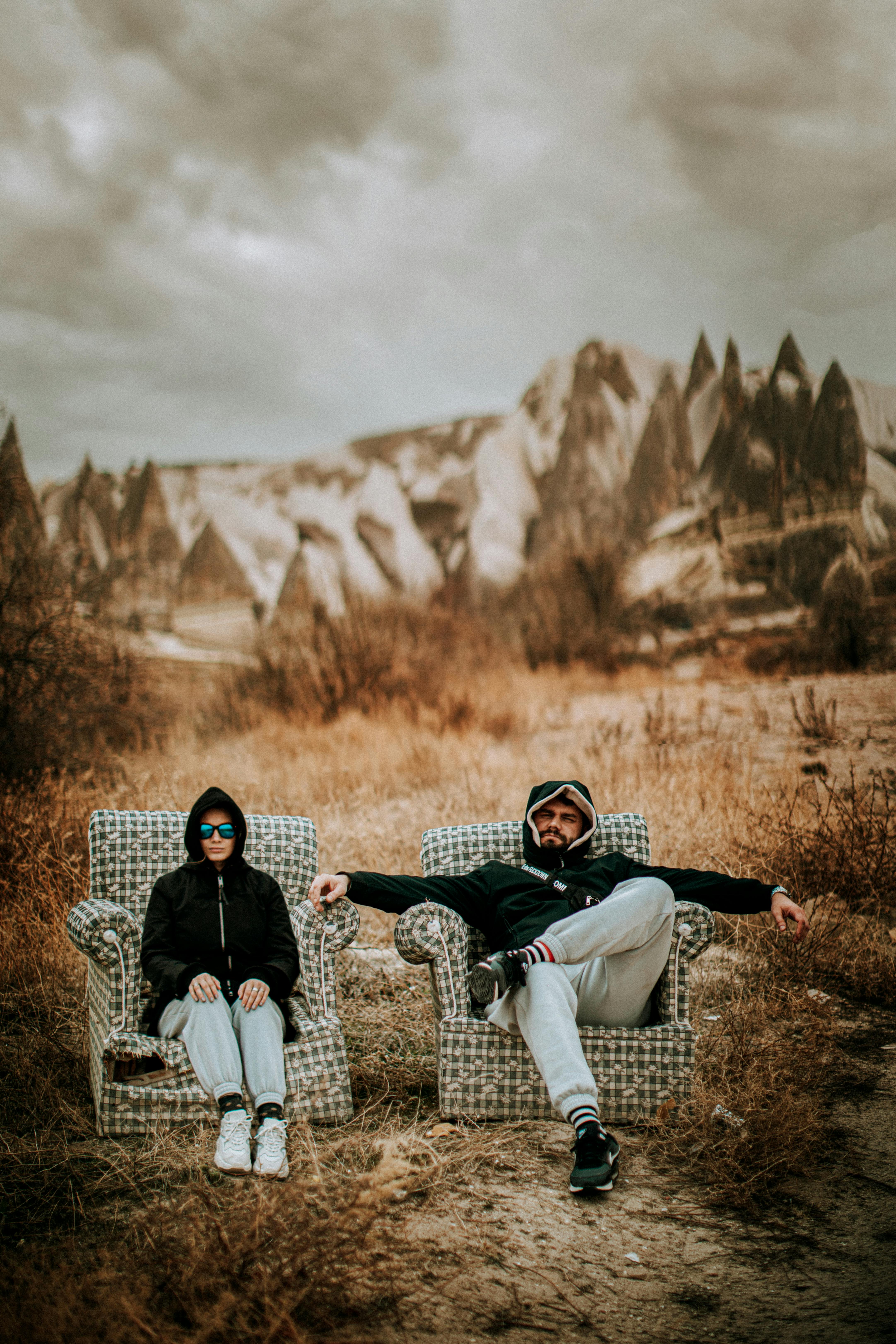 Two People Sitting on the Chair Outside · Free Stock Photo