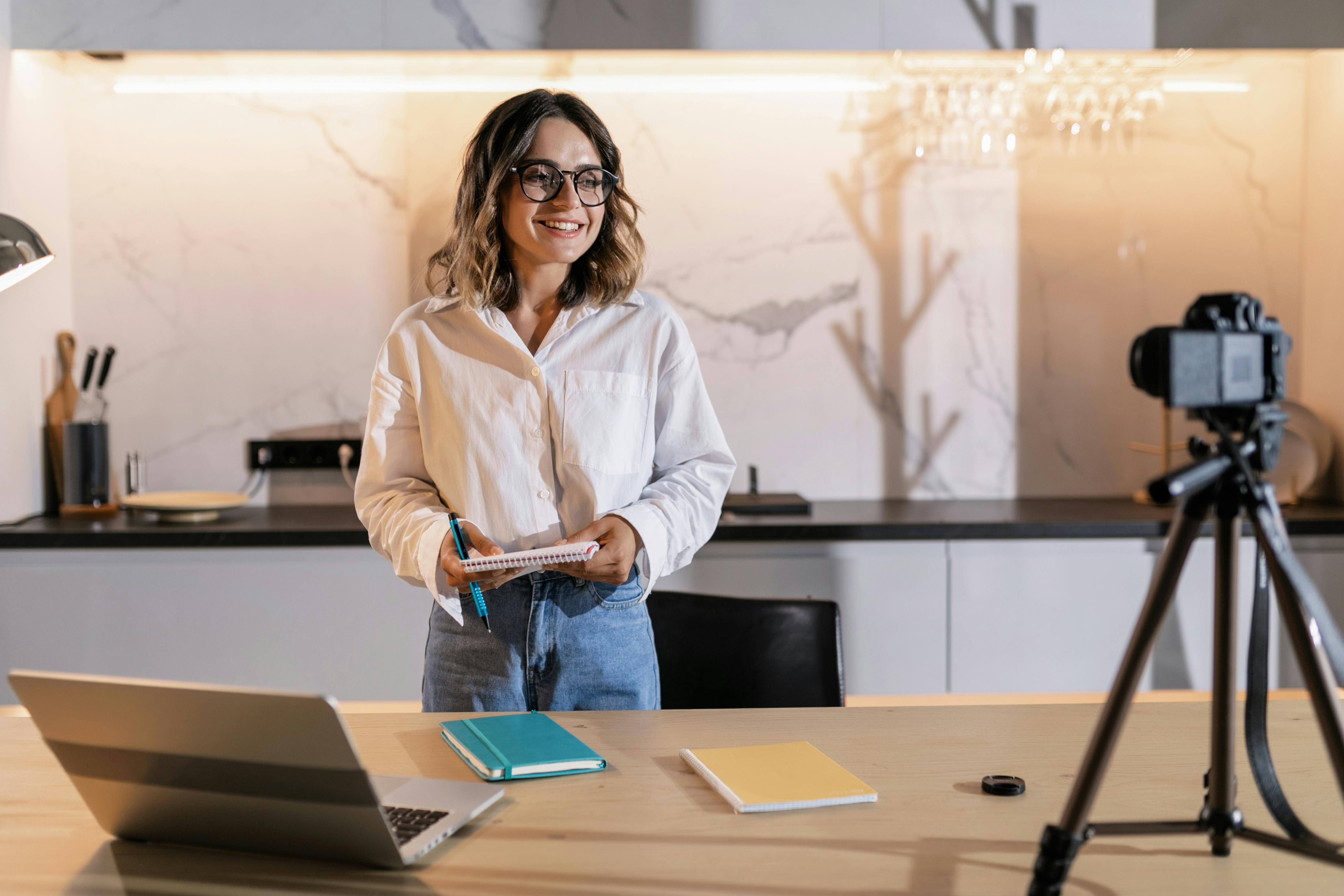 Smiling Woman Holding a Notebook · Free Stock Photo