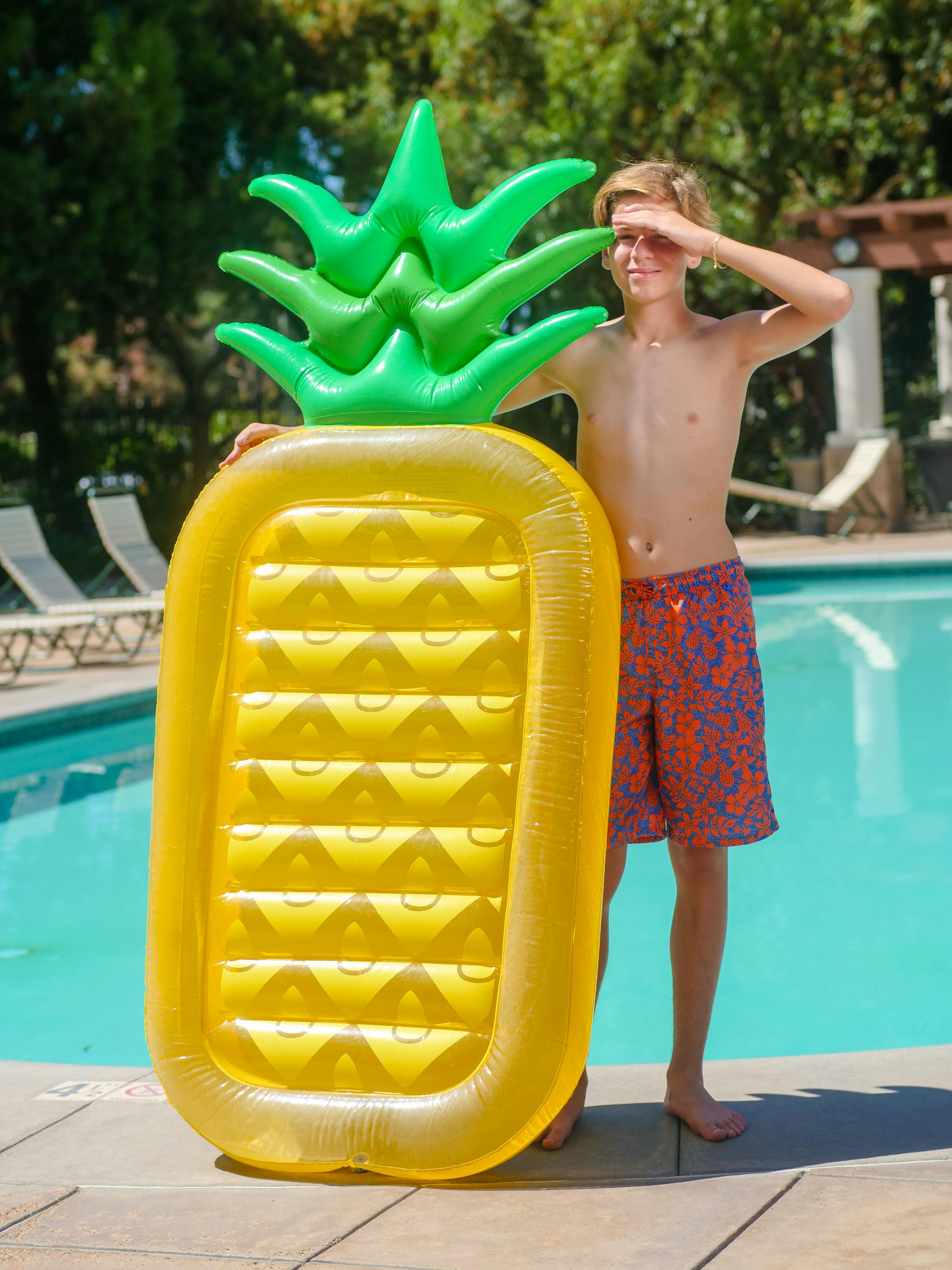 A Boy Holding Yellow Floater · Free Stock Photo