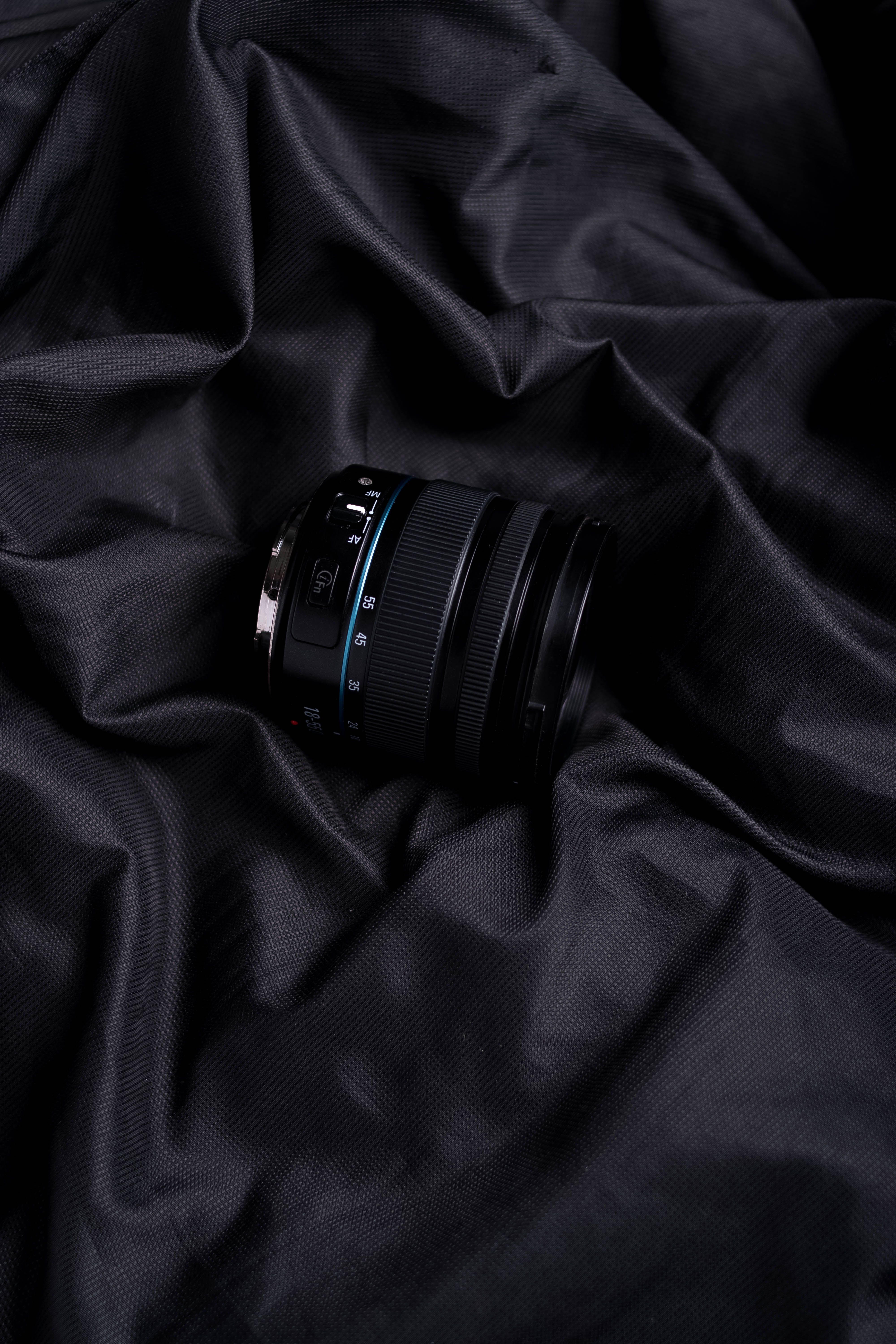 A Camera Lens on Black Textile · Free Stock Photo