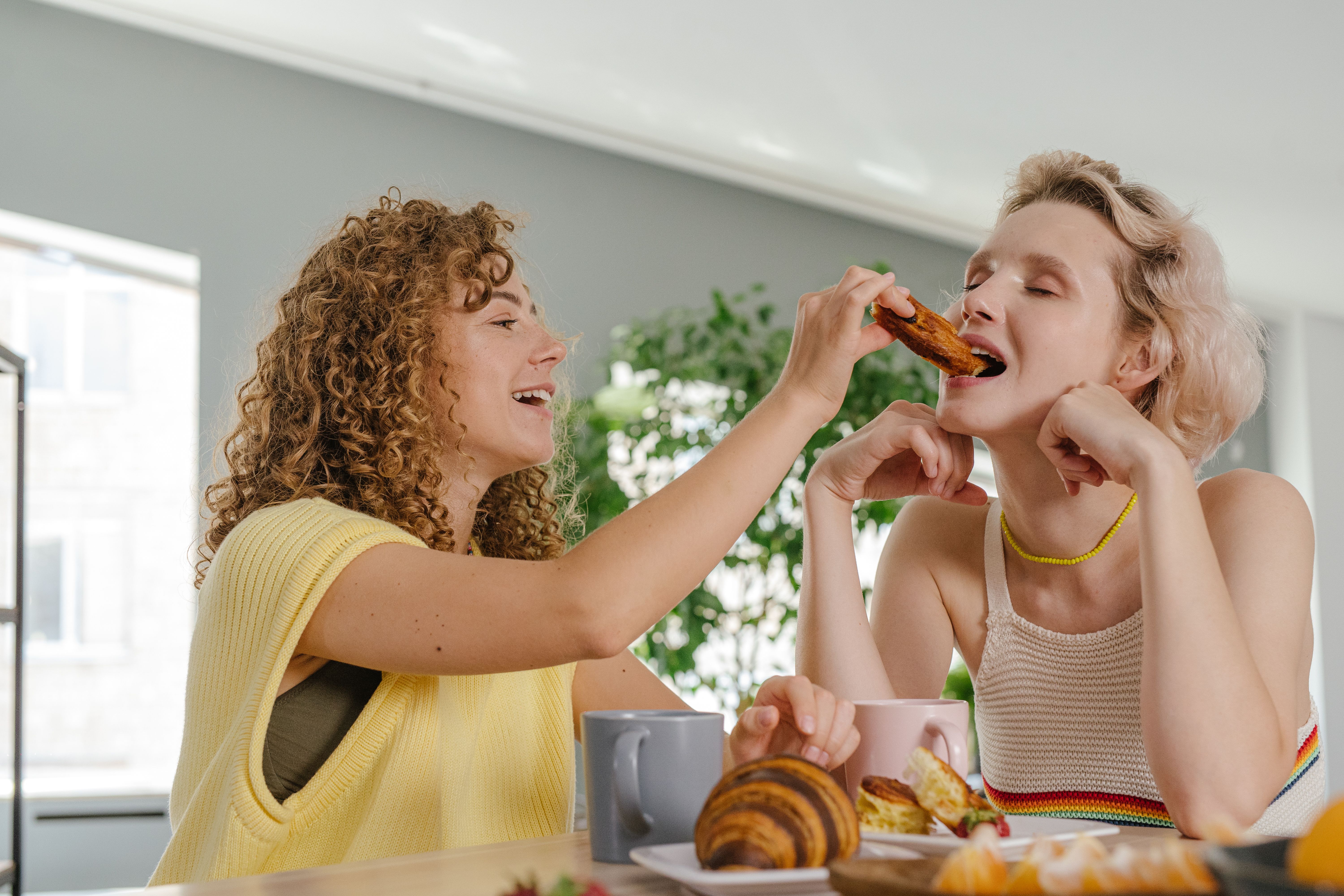 Woman Feeding Friend with Breakfast · Free Stock Photo