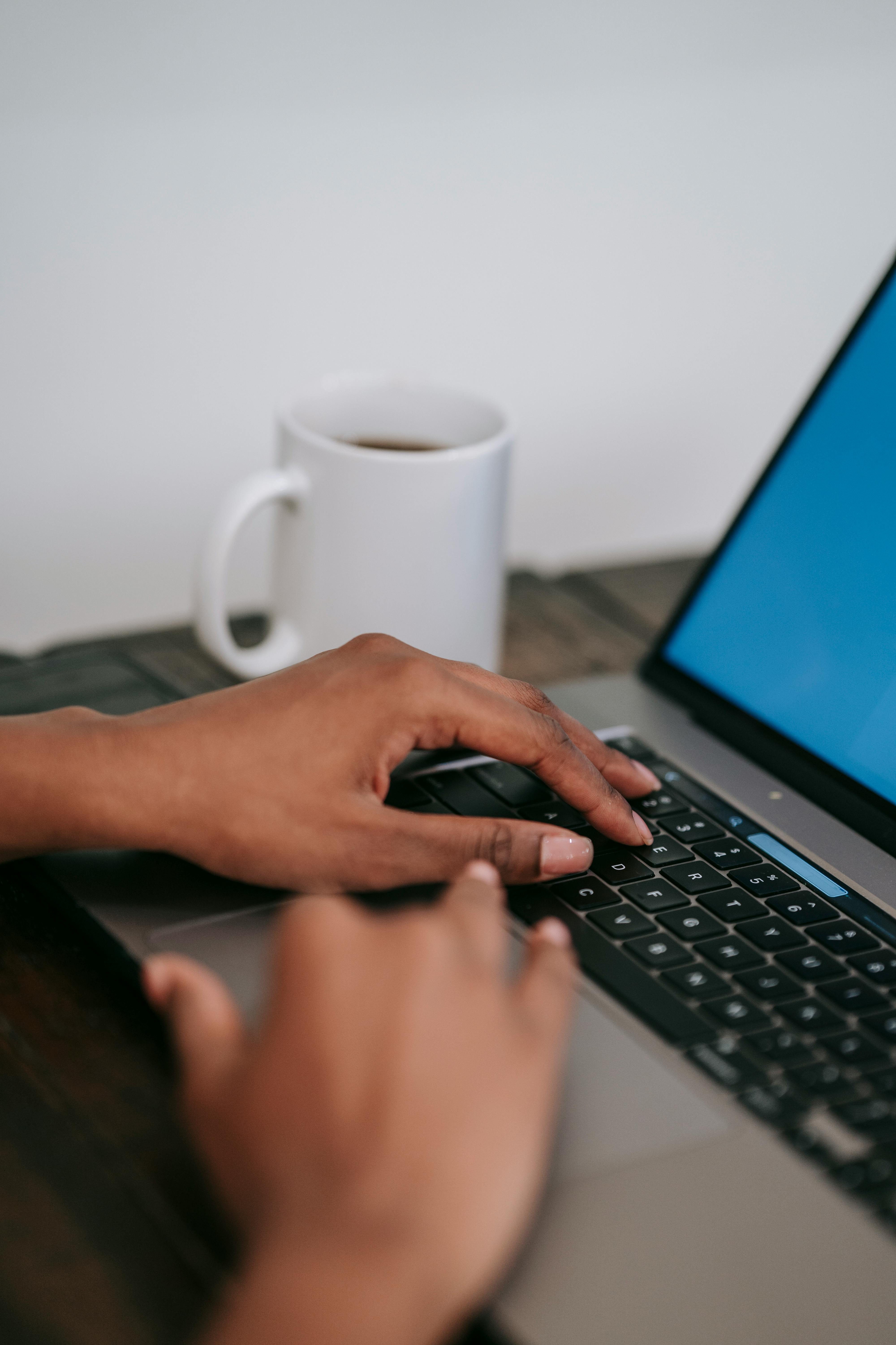 Unrecognizable person typing on laptop · Free Stock Photo