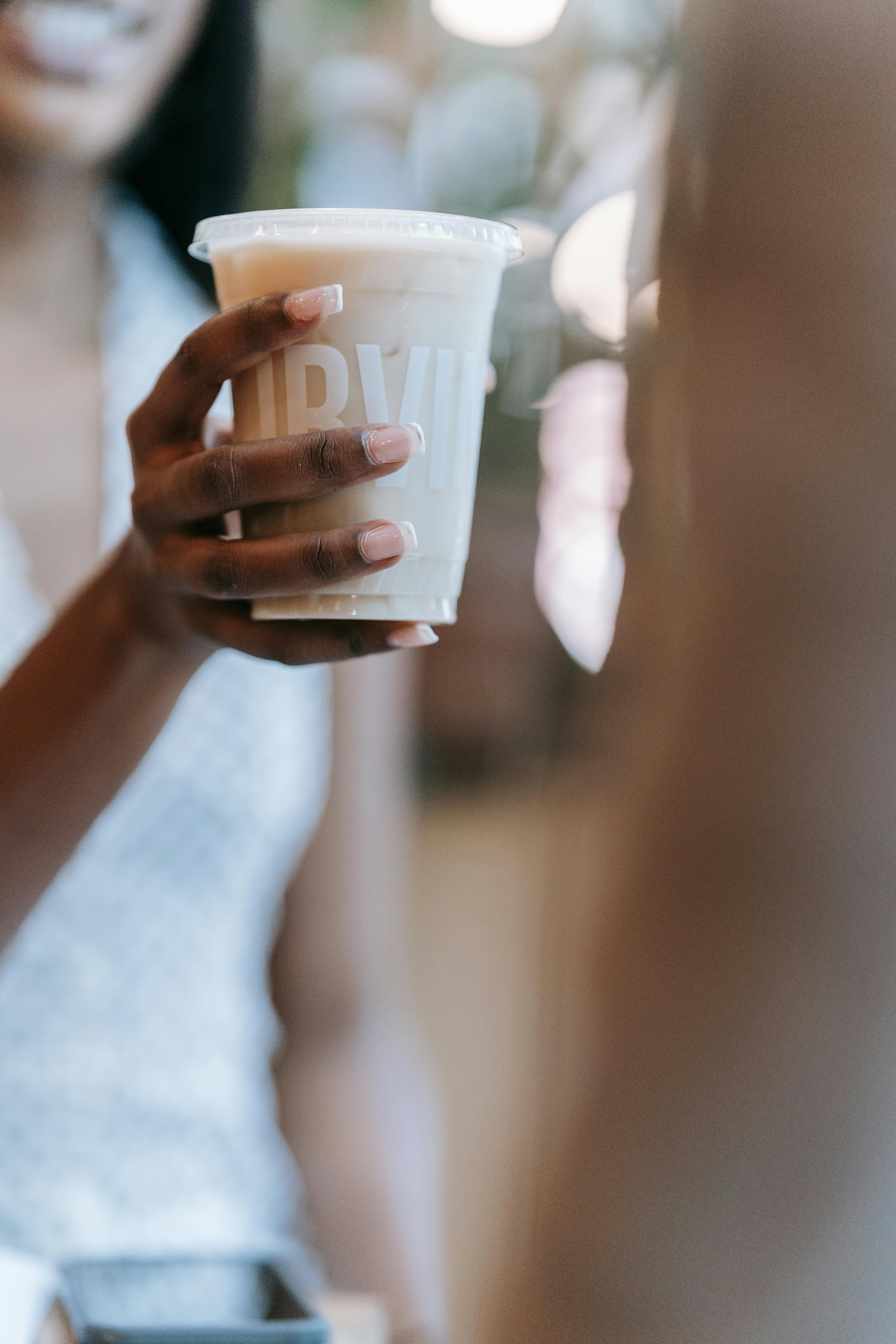 A Person Holding a Plastic Cup · Free Stock Photo