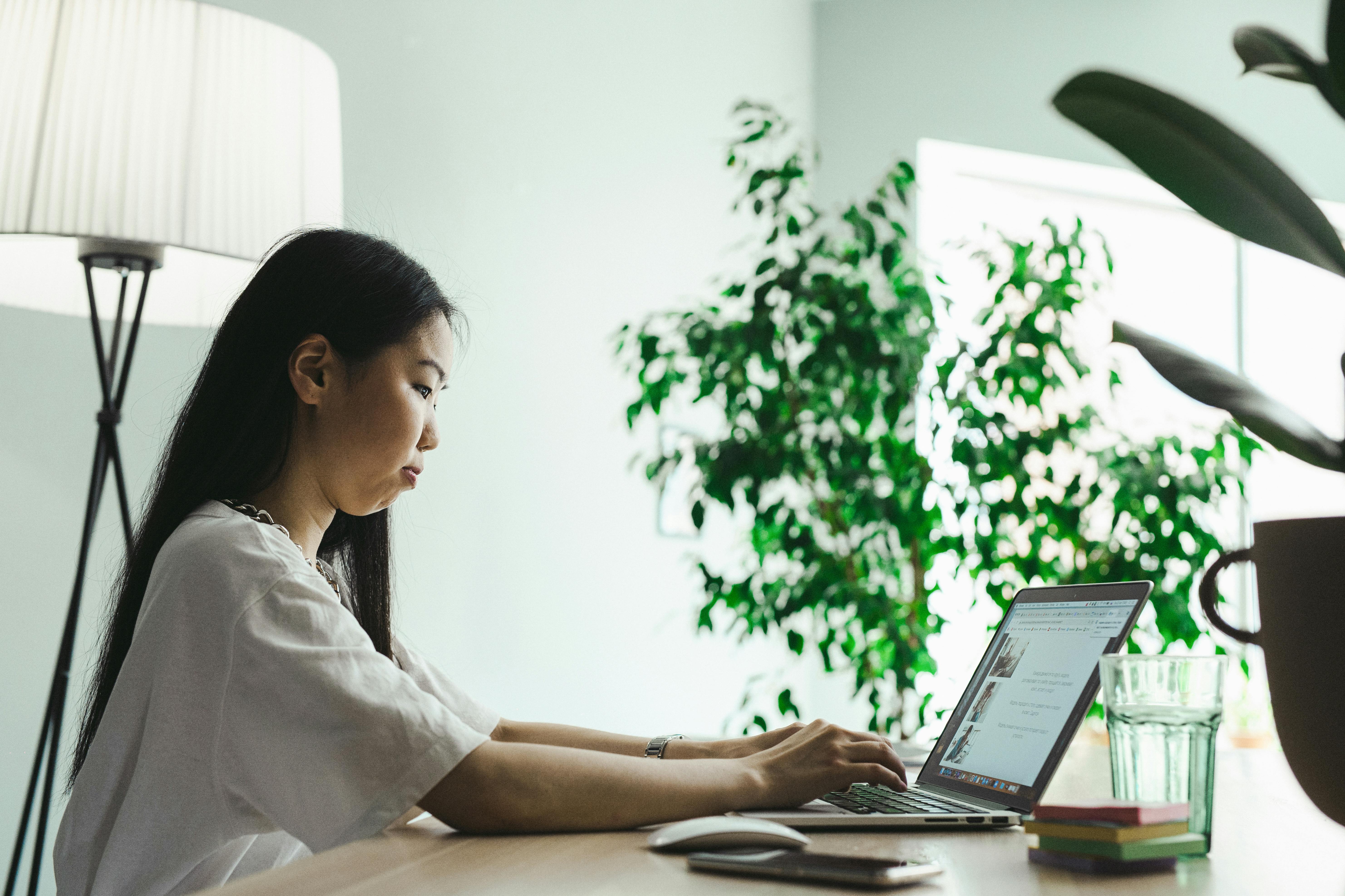 Woman Using Silver Laptop · Free Stock Photo