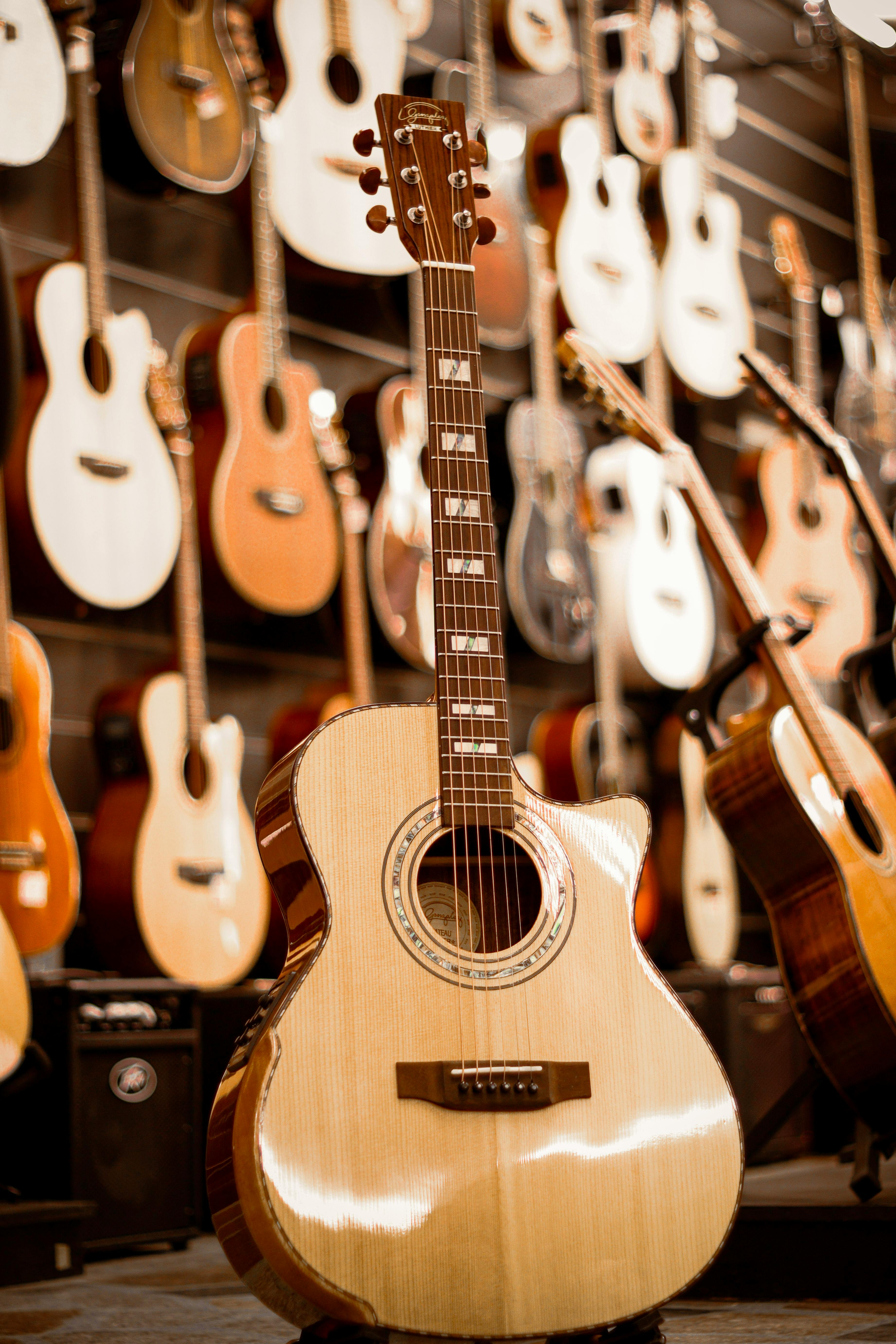 Close-Up Shot of a Brown Acoustic Guitar · Free Stock Photo