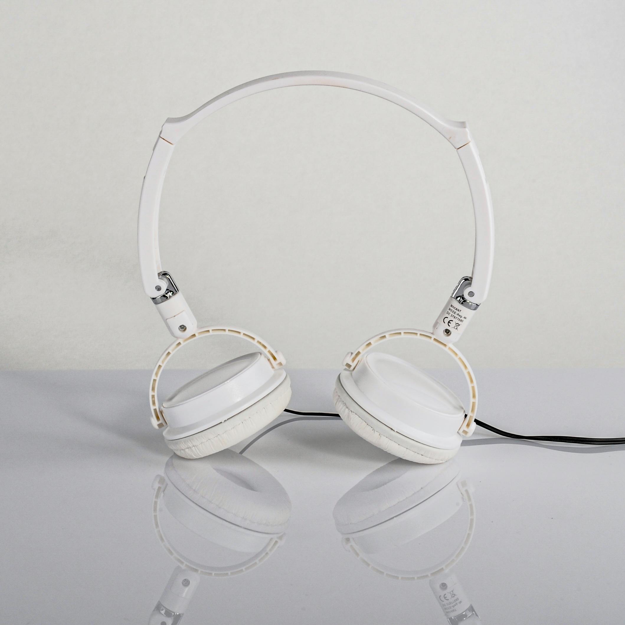 Close-Up Shot of White Headphones on a White Surface · Free Stock Photo