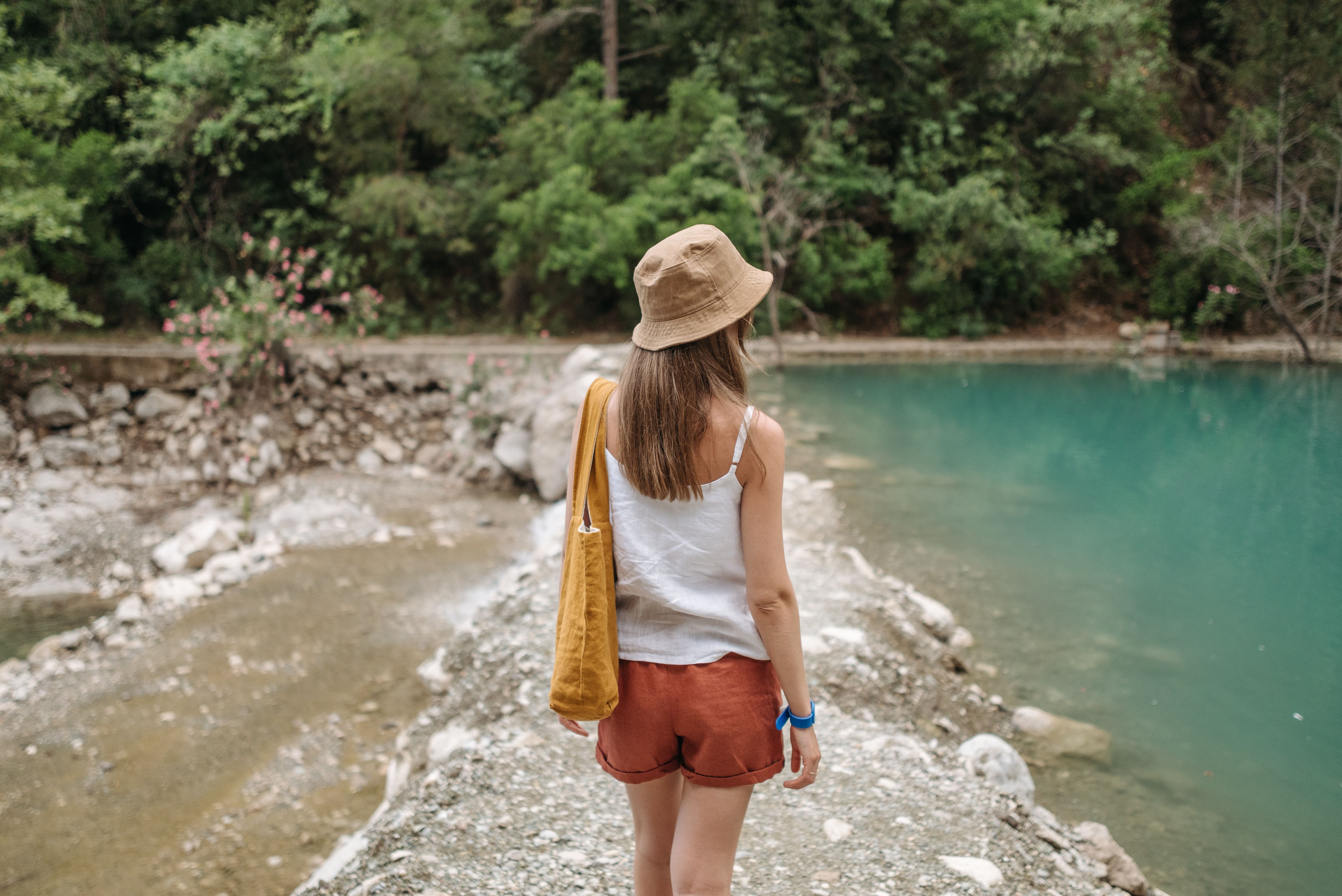 Woman in White Tank Top Standing Beside a River · Free Stock Photo