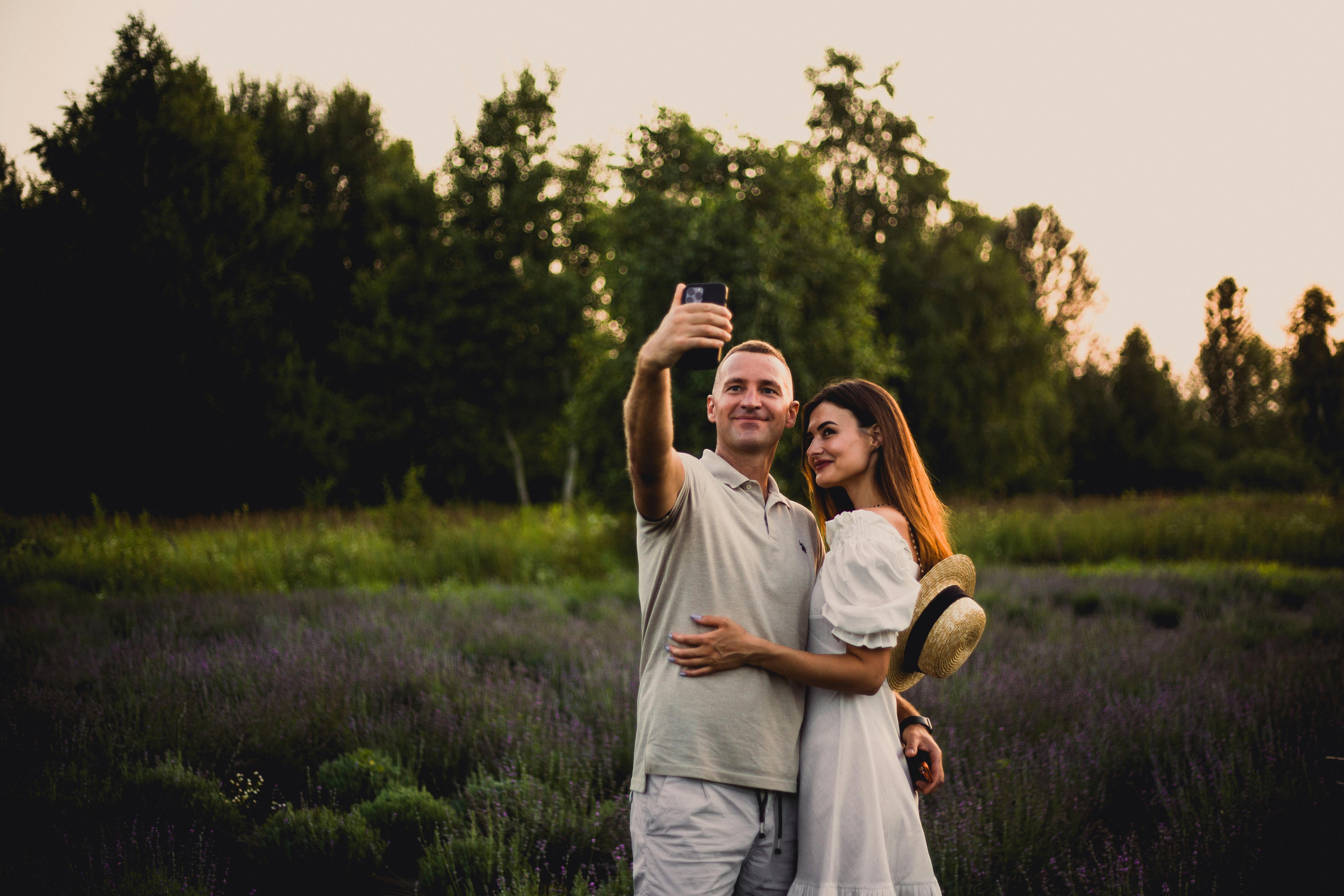 Romantic Couple Taking Photo of Themselves using a Cellphone while ...