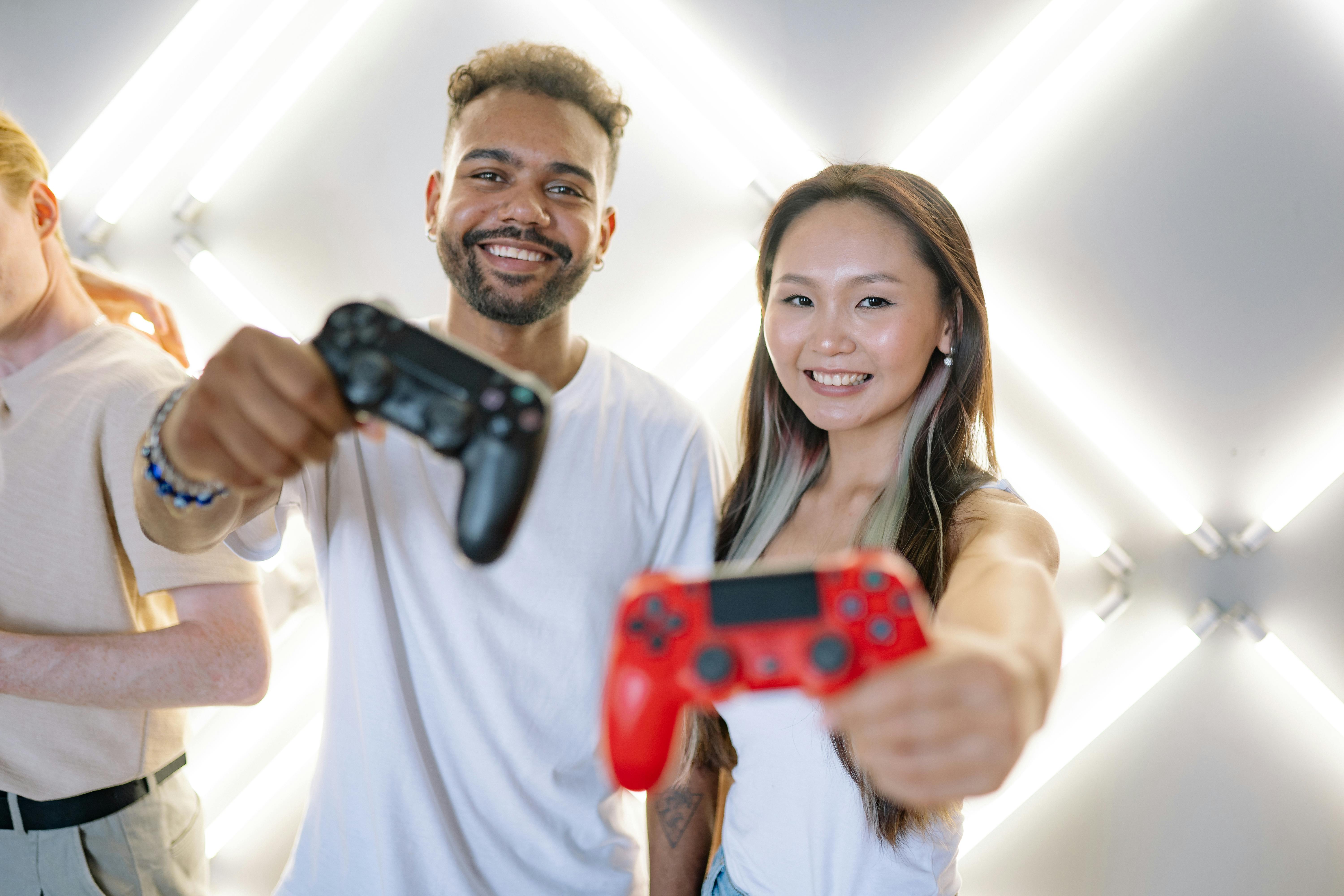 Man and Woman Smiling while Holding Game Controllers · Free Stock Photo