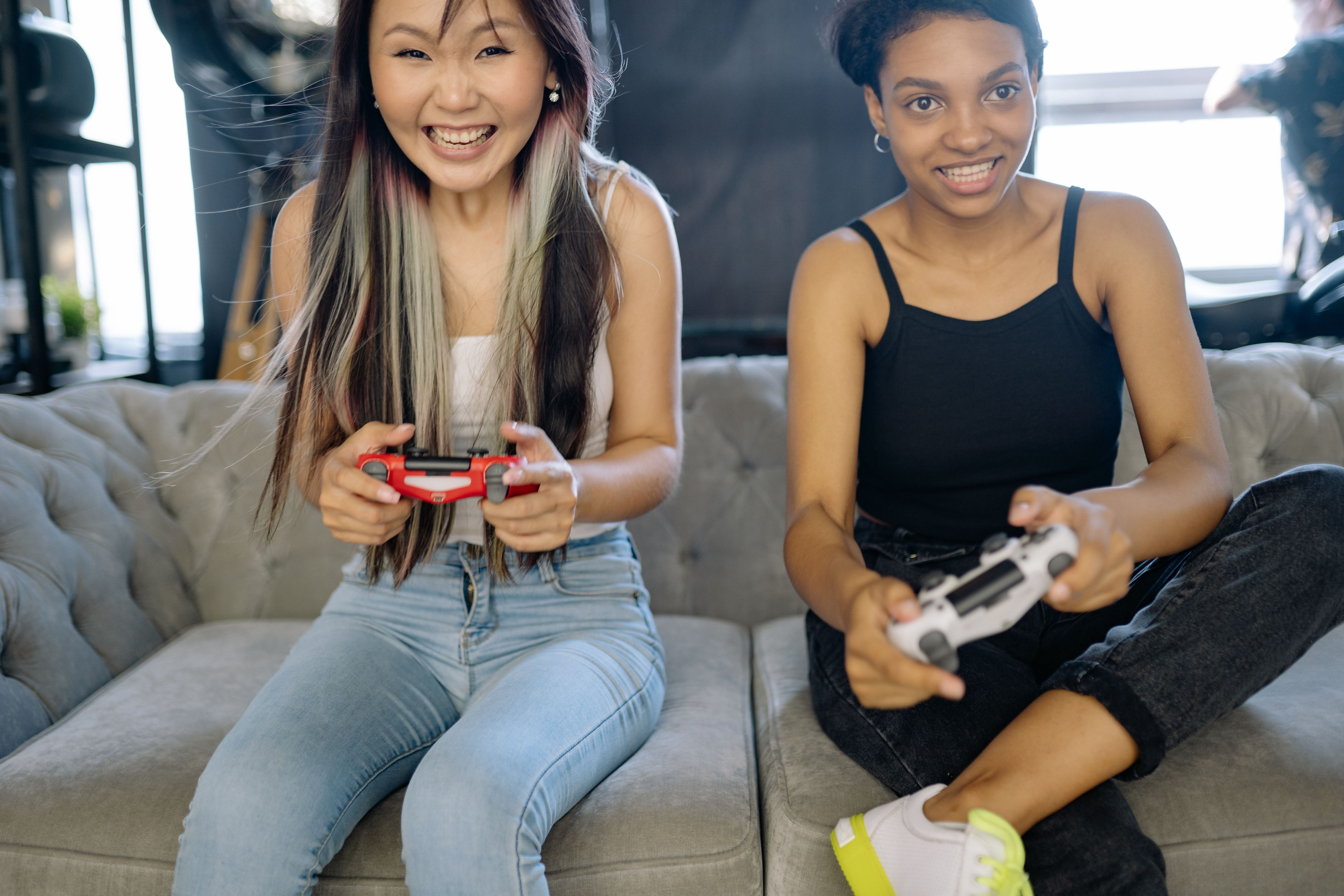 A Boy Playing Video Games while Sitting on a Sofa · Free Stock Photo