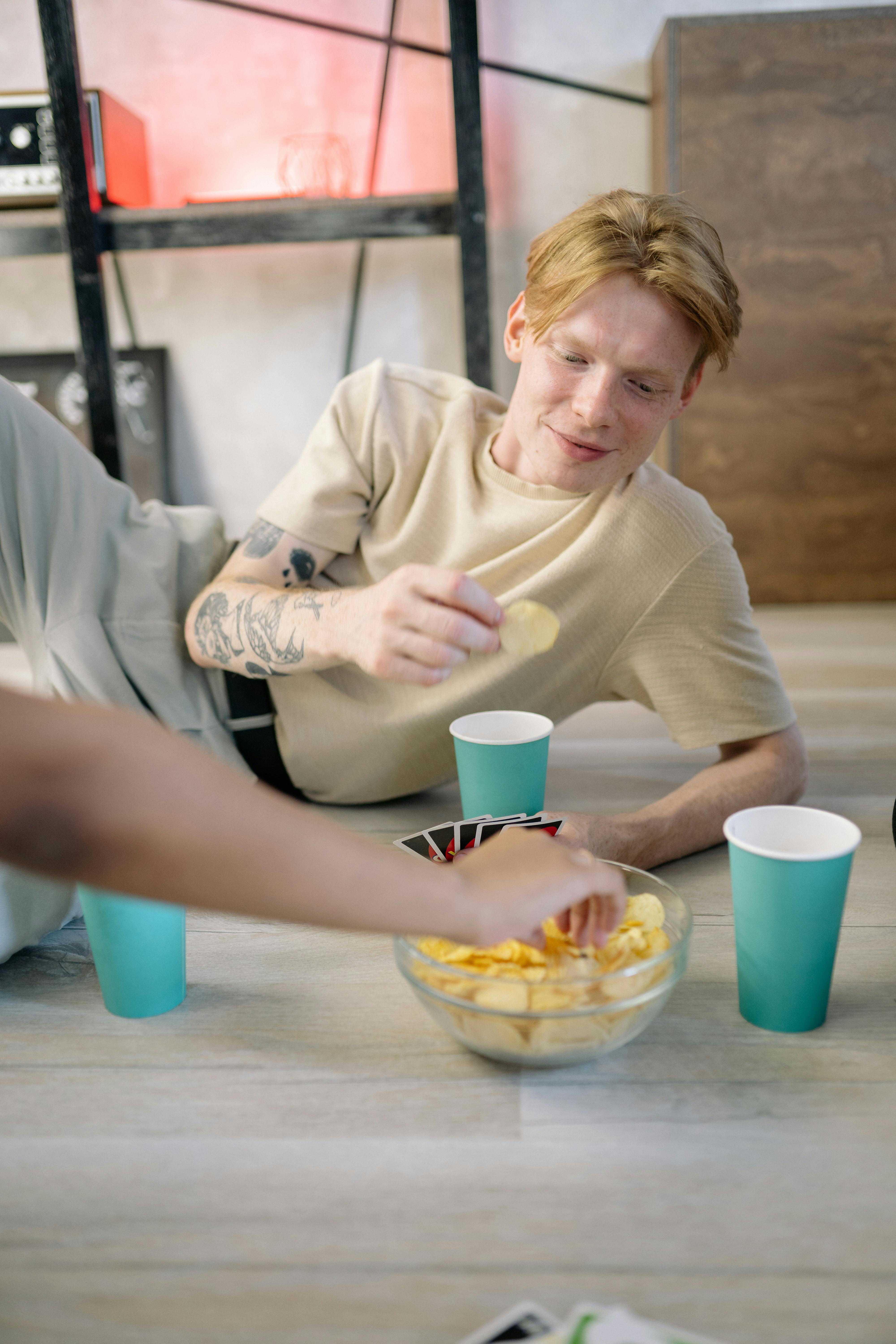 Woman Eating Snacks at Table · Free Stock Photo