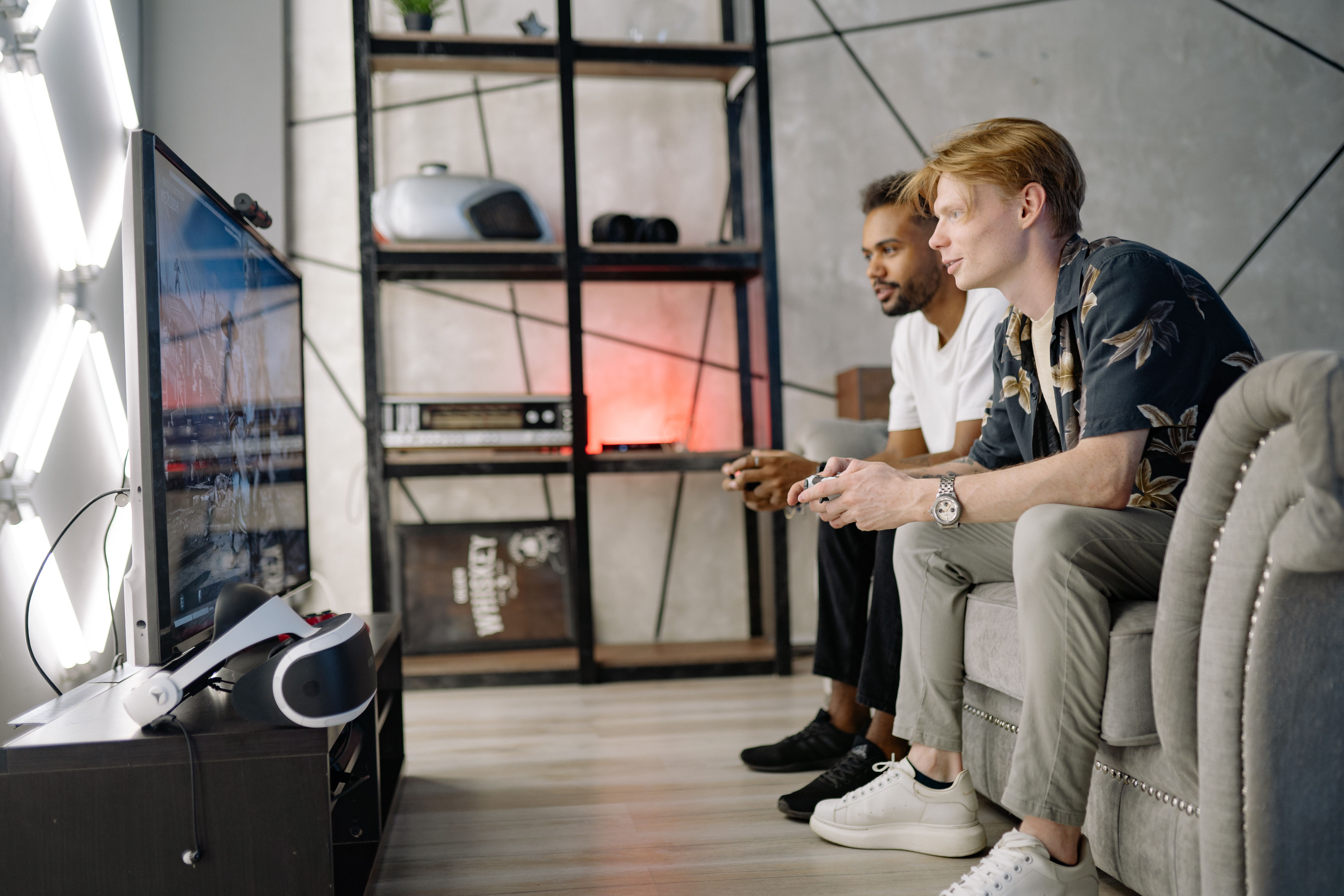 A Man and Woman Playing Video Games while Sitting on the Couch · Free ...