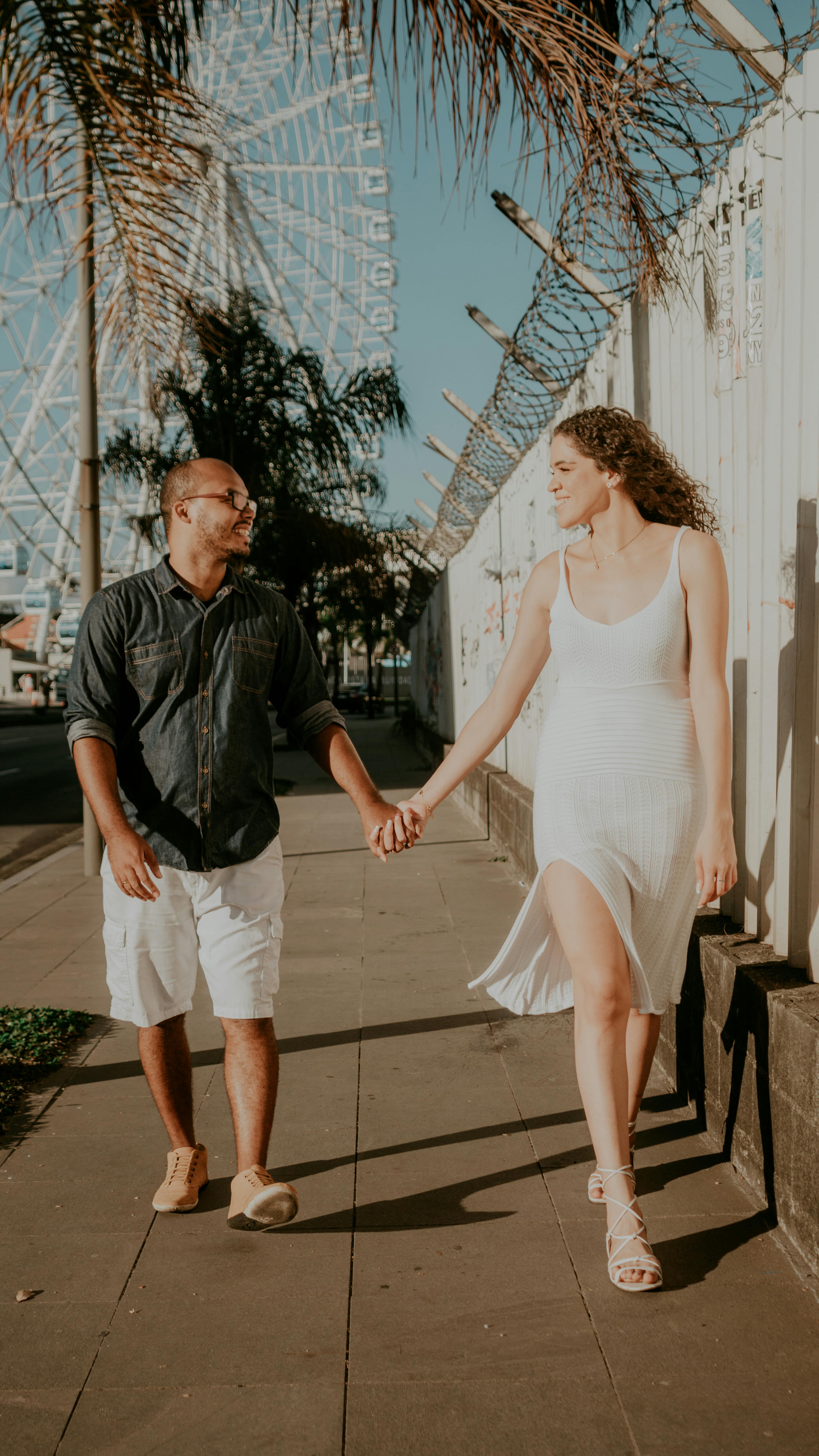 Couple Holding Hands While Walking on Sidewalk · Free Stock Photo