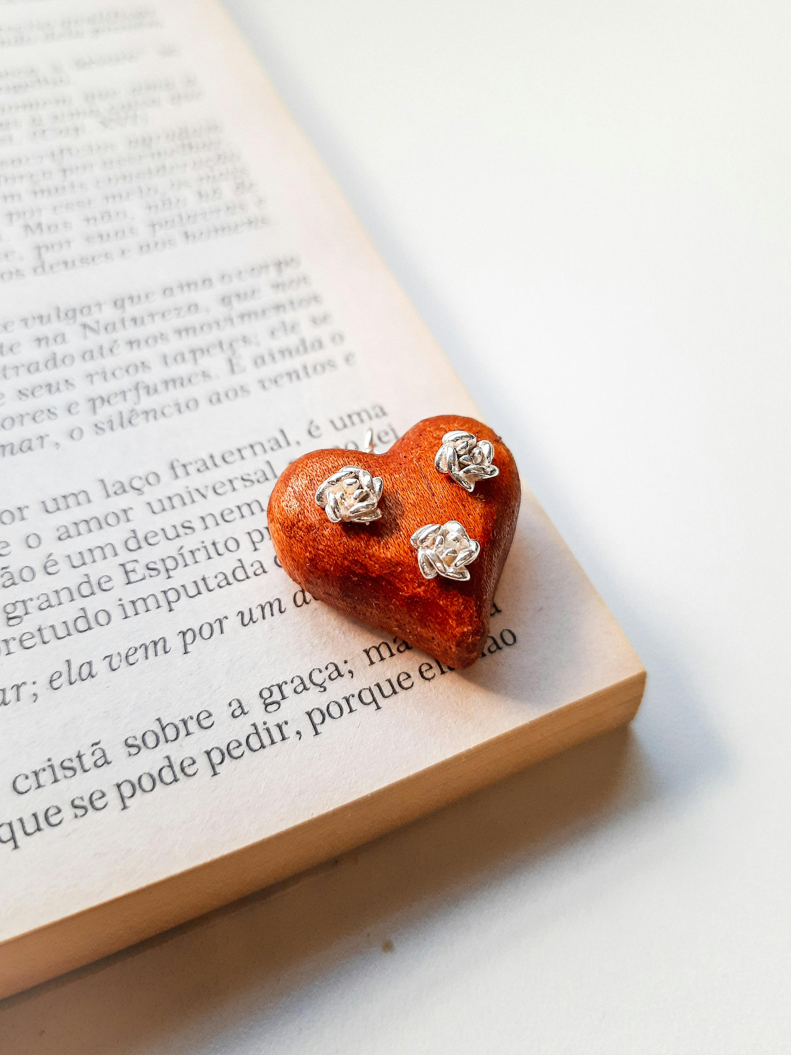 Book with decorative heart and flowers on page · Free Stock Photo