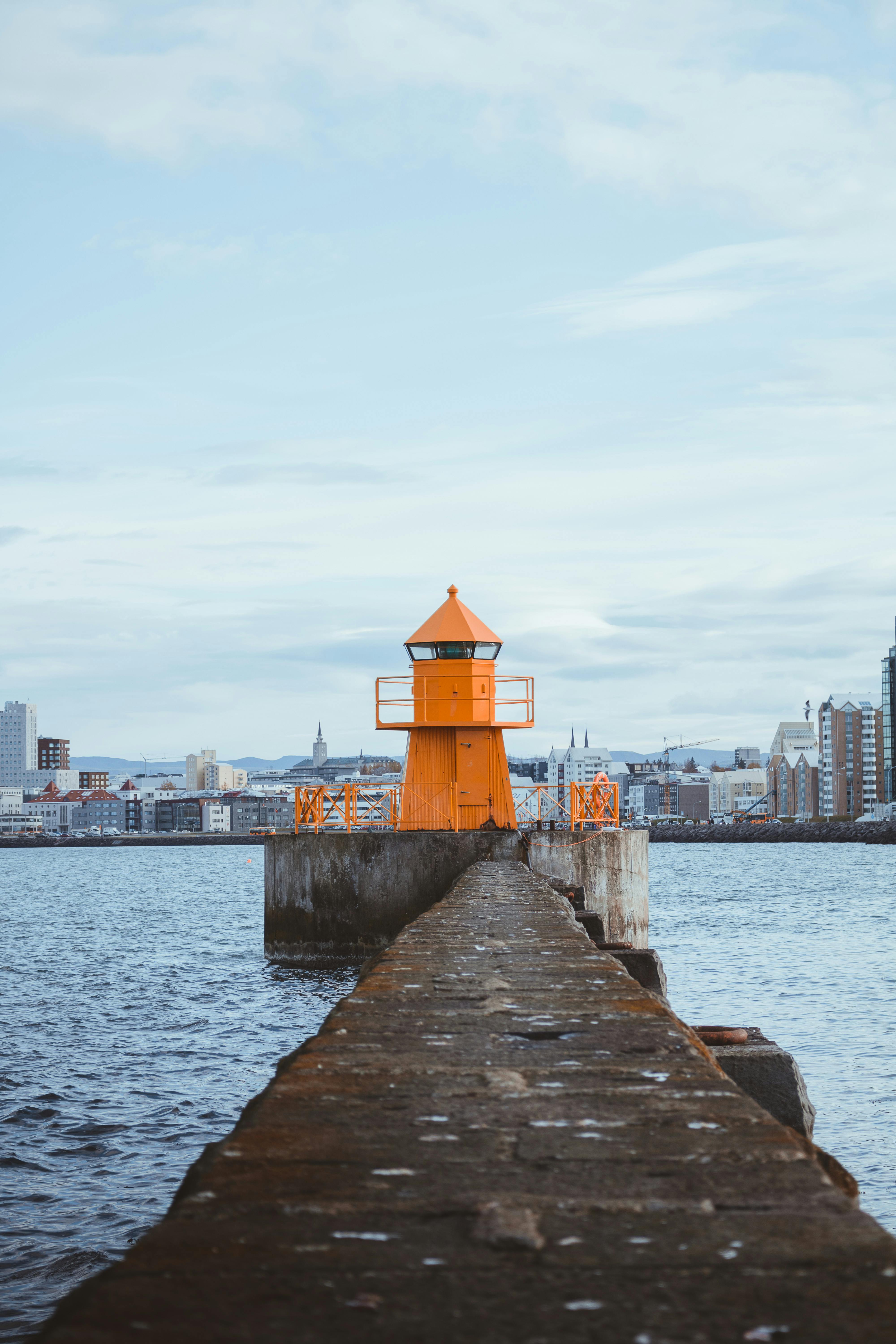 A Lighthouse on the Body of Water · Free Stock Photo