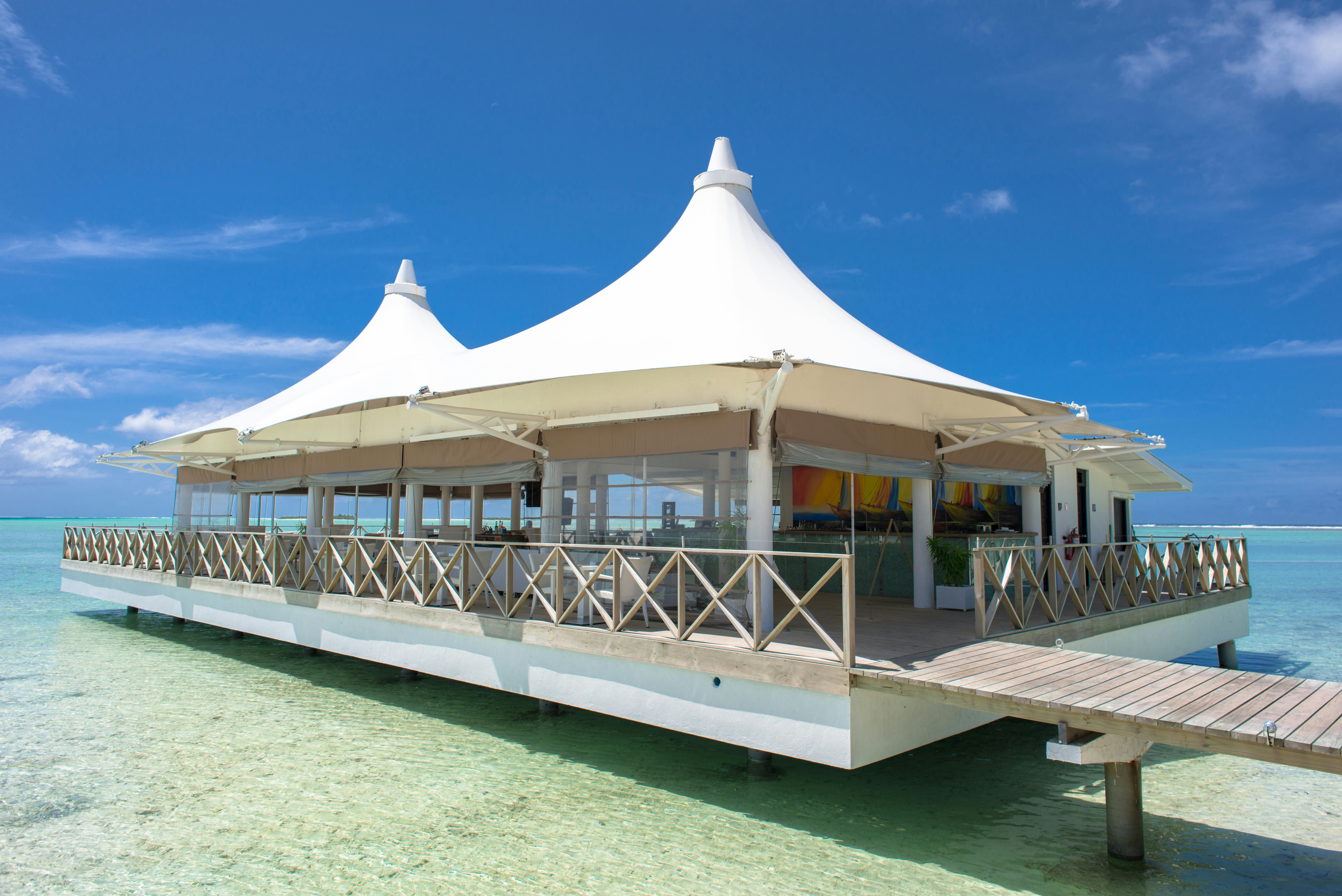 White and Brown Wooden Gazebo on Green Body of Water Under Blue Sky ...