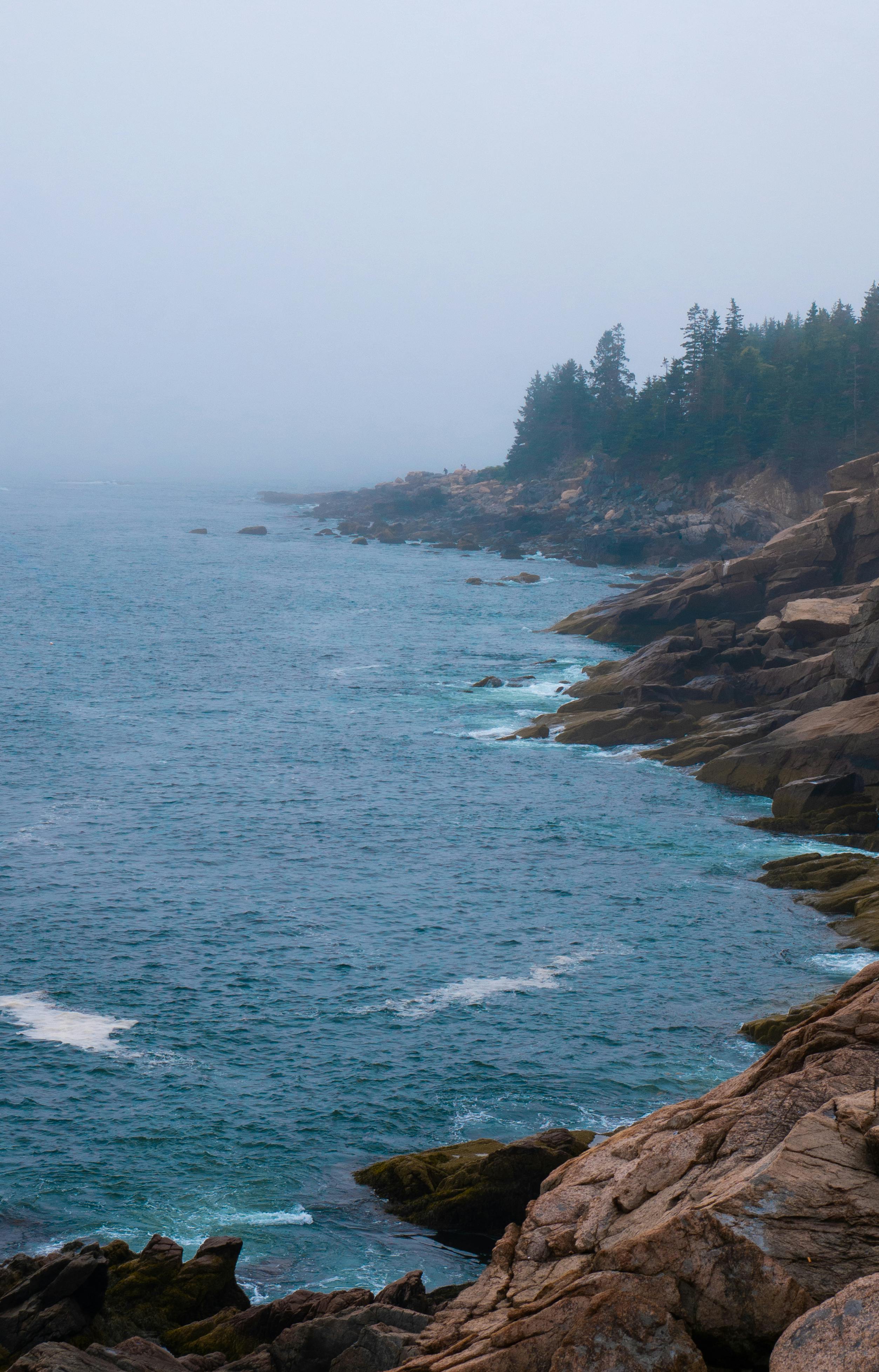 White Dome Building Near Sea Under Gray Sky · Free Stock Photo
