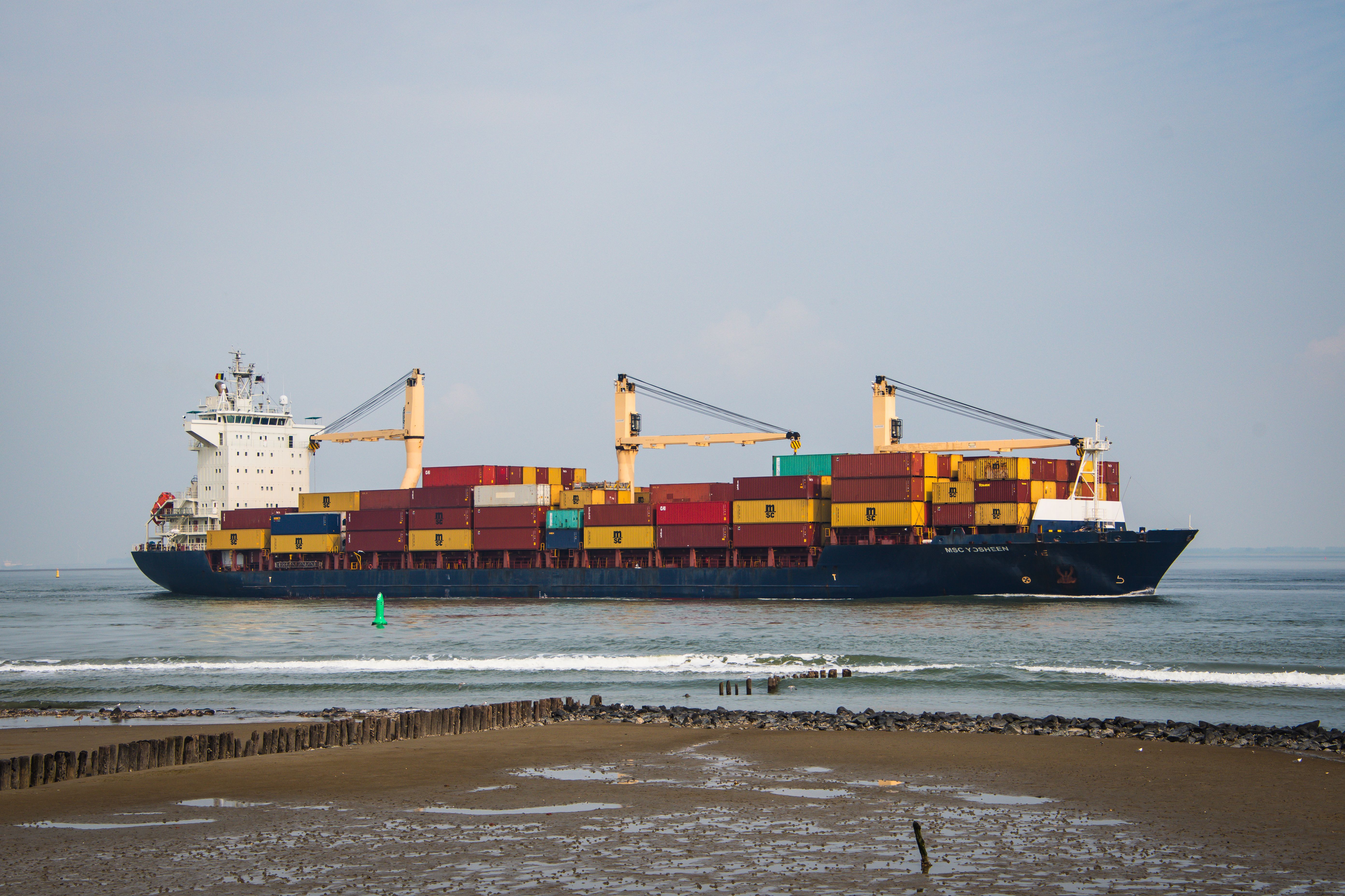 A Green Cargo Ship on the Sea · Free Stock Photo