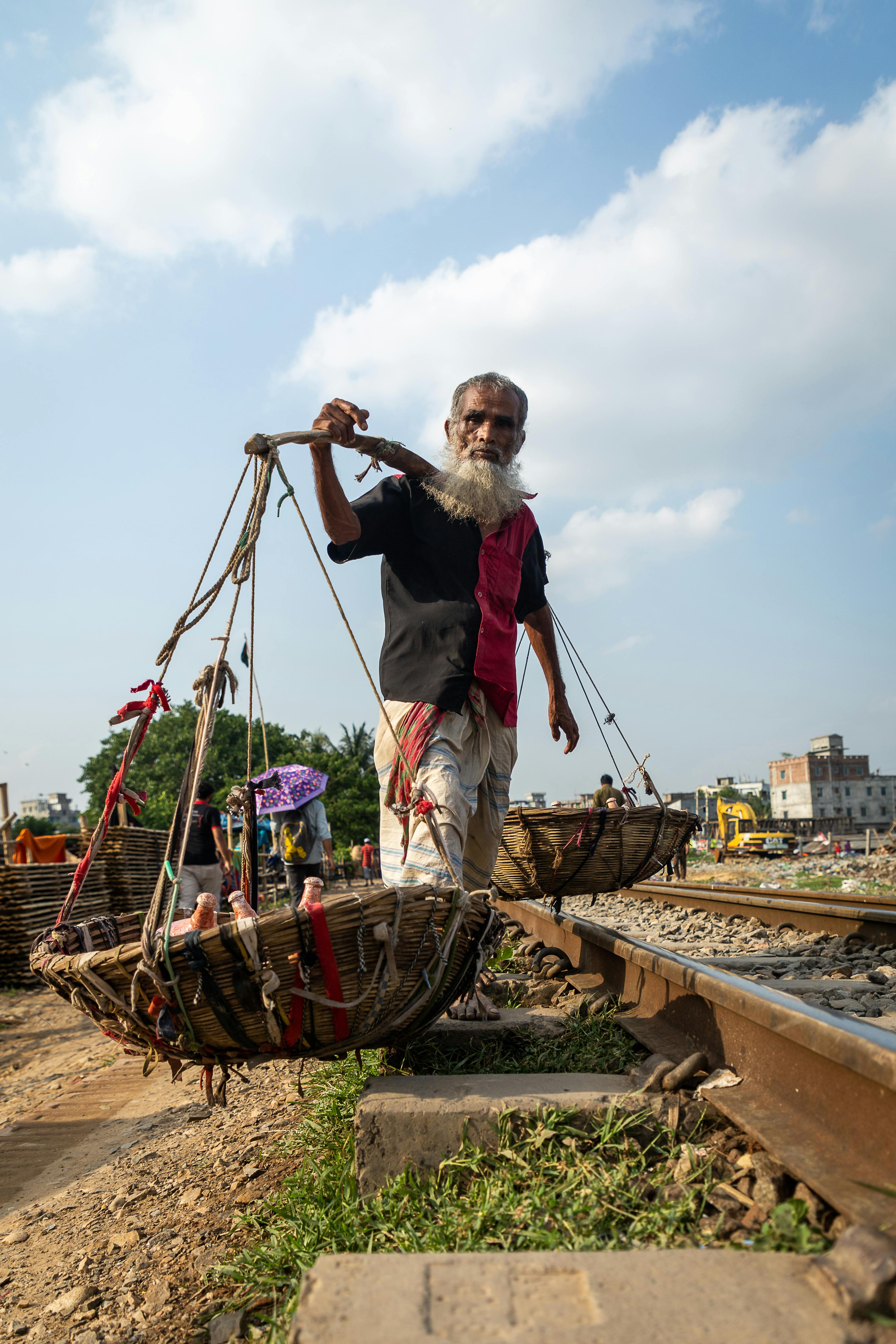Man Carrying Baskets · Free Stock Photo