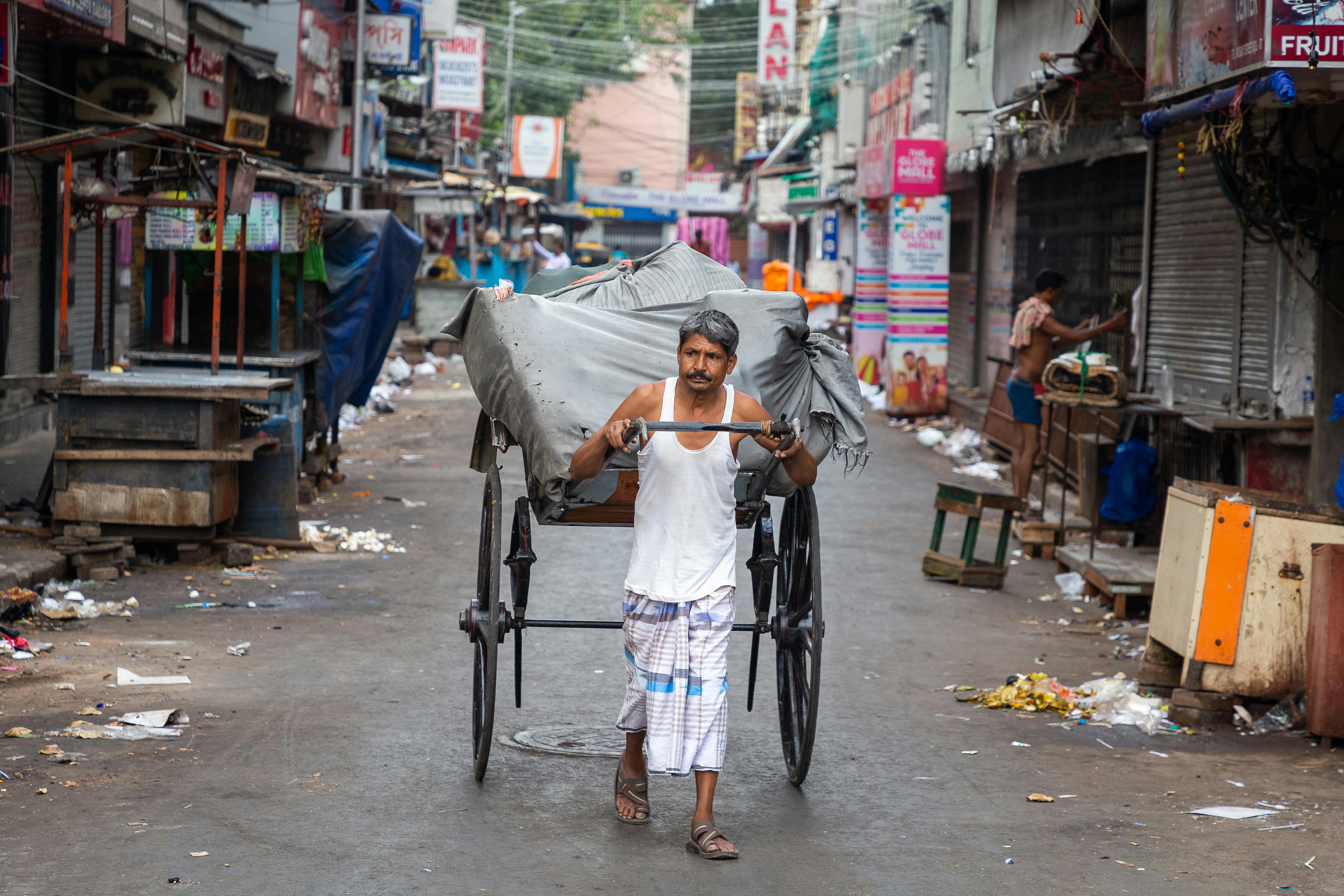 A Garbage Man with Cart of Paper Waste · Free Stock Photo