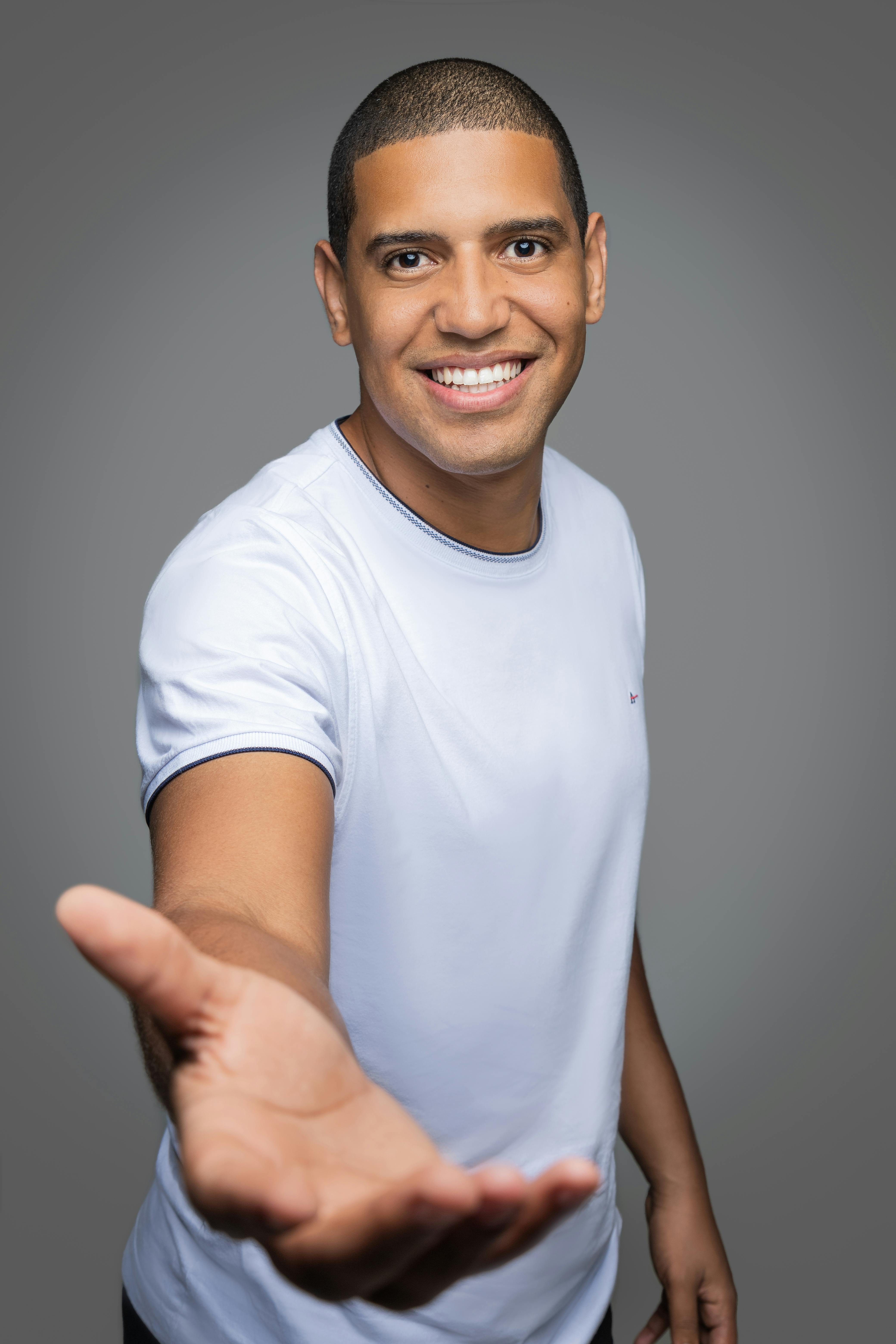 A Man in a White Shirt with His Hand Out · Free Stock Photo