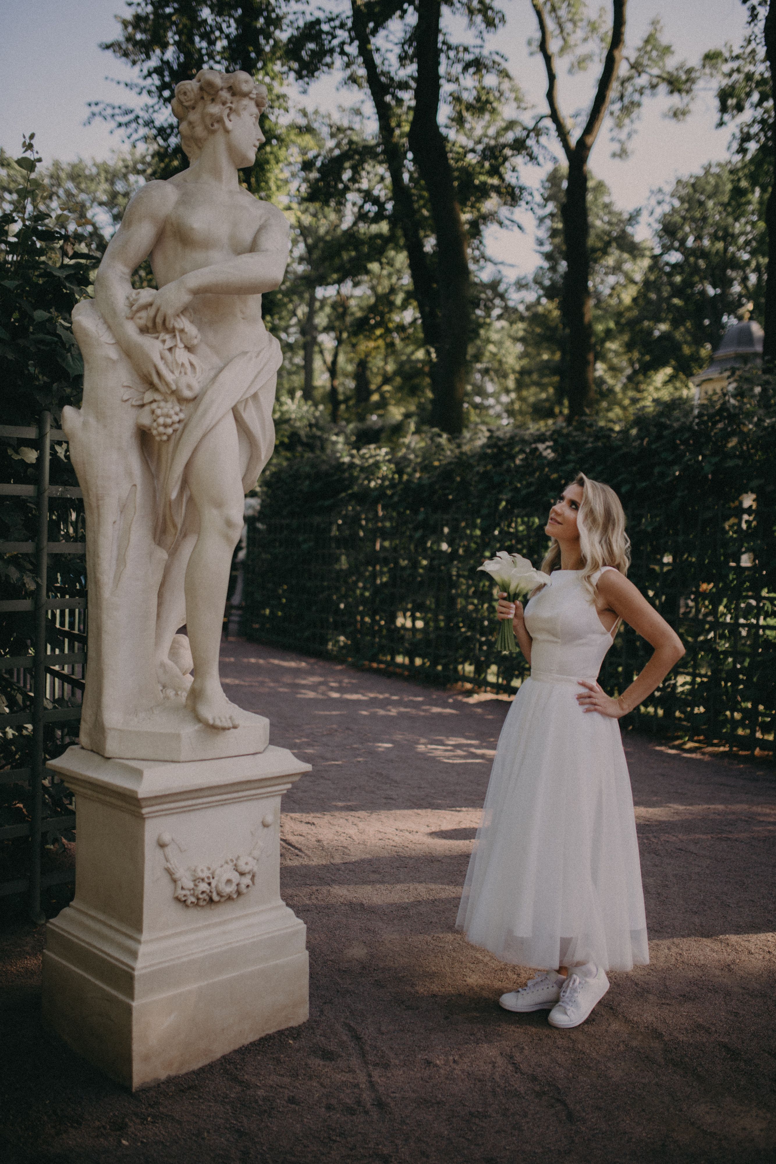 A Girl Staring at the Hanging Wedding Dress · Free Stock Photo