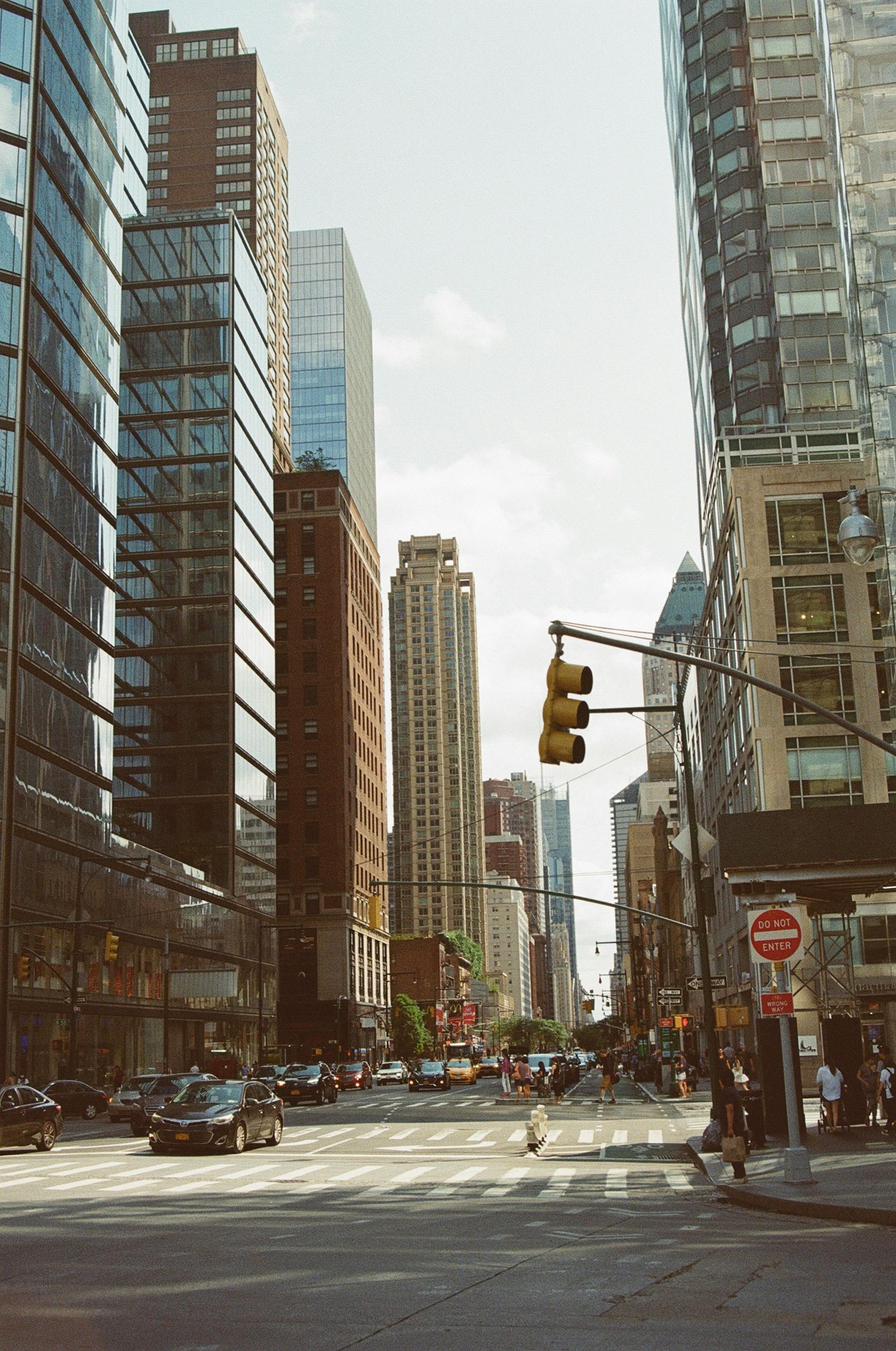 Cars on Road Between High Rise Buildings · Free Stock Photo
