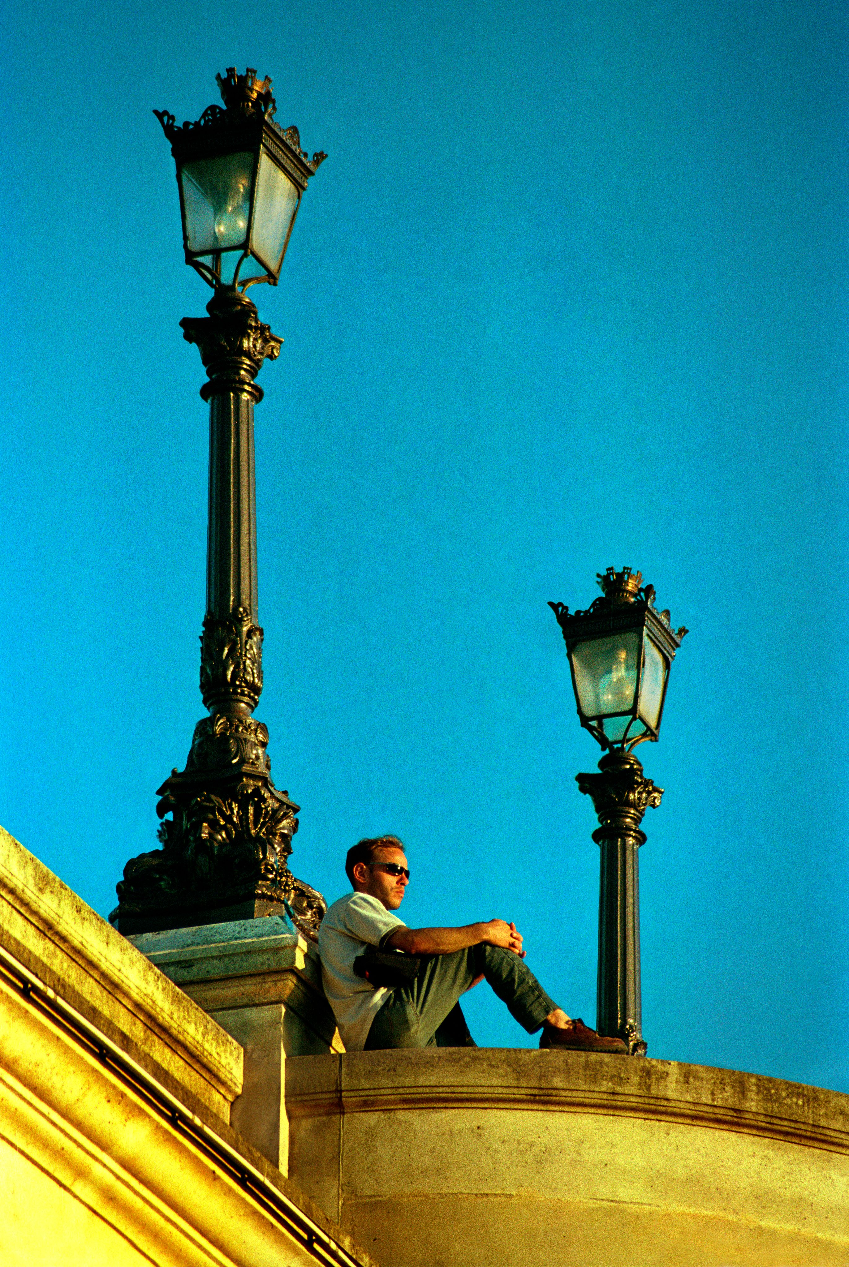 A Man Sitting on a Ledge · Free Stock Photo