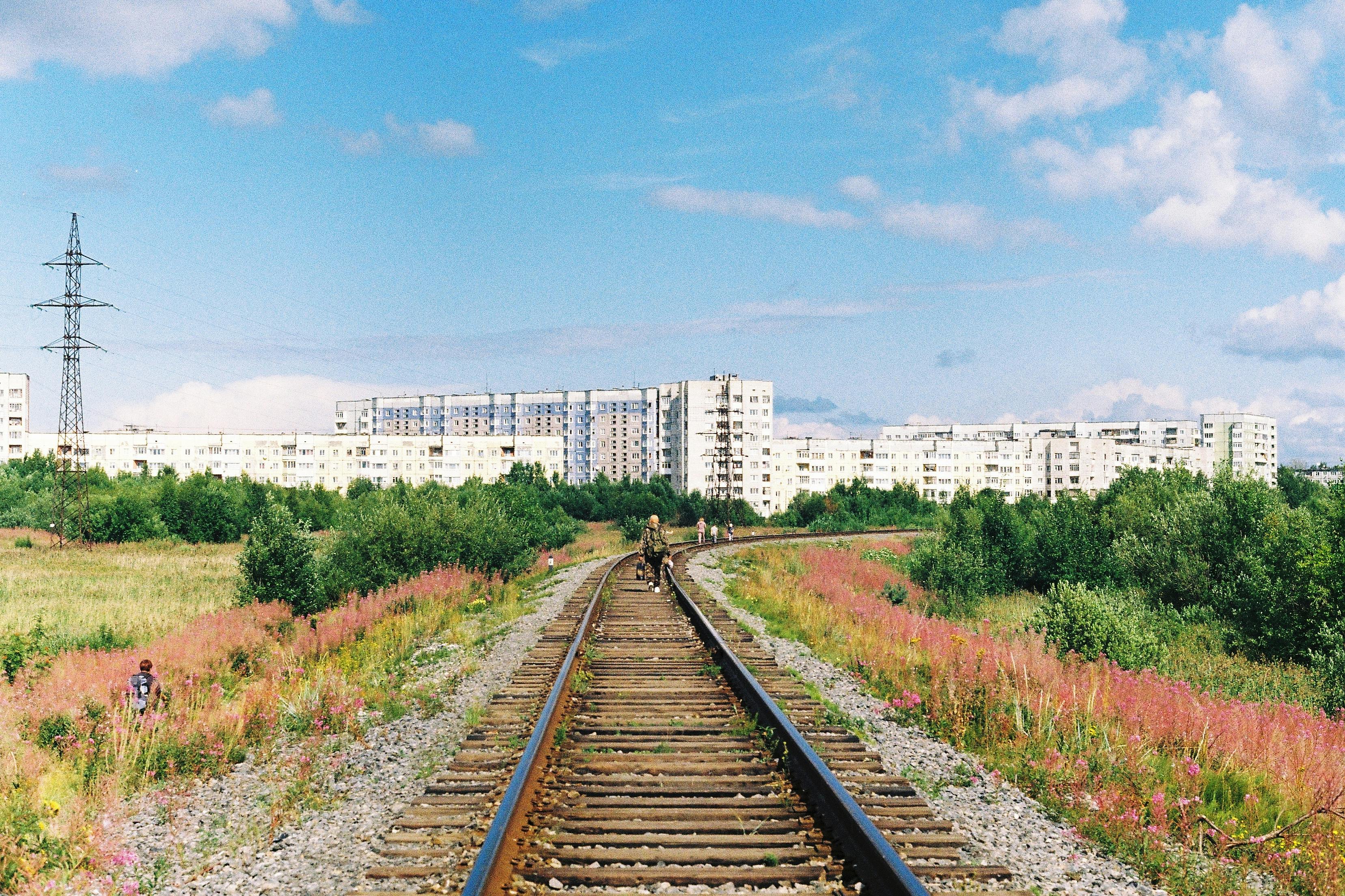 People Walking on Railway Tracks · Free Stock Photo