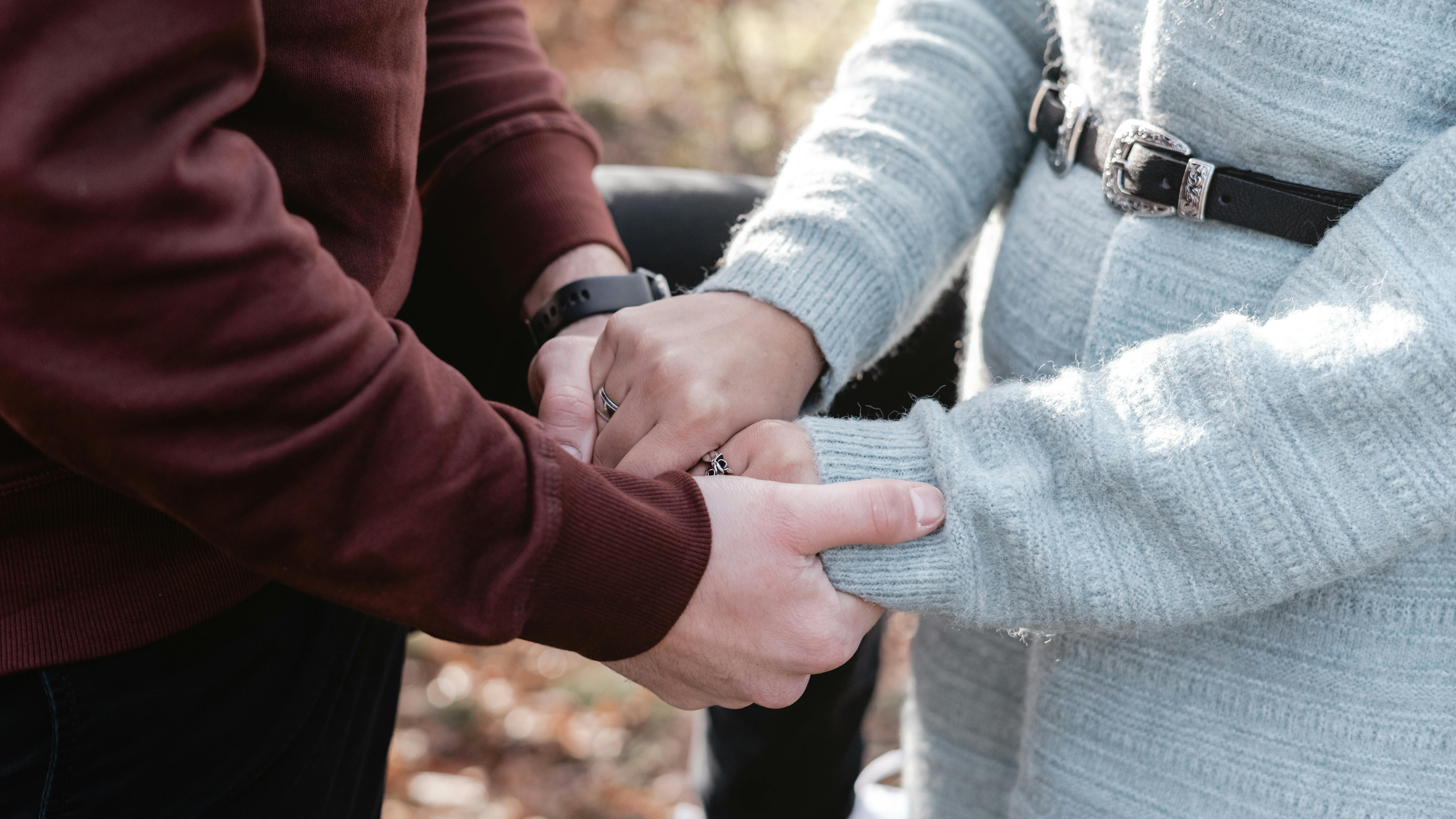 A Couple Holding Each Others Hand · Free Stock Photo